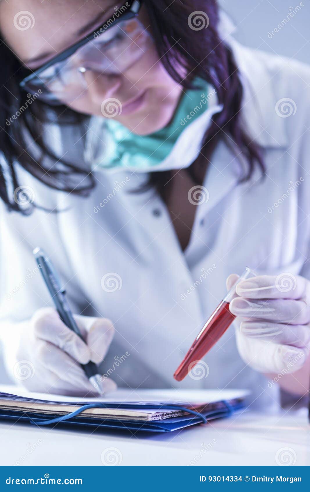 Female Laboratory Worker Dealing with Flask Containing Liquid Chemicals ...