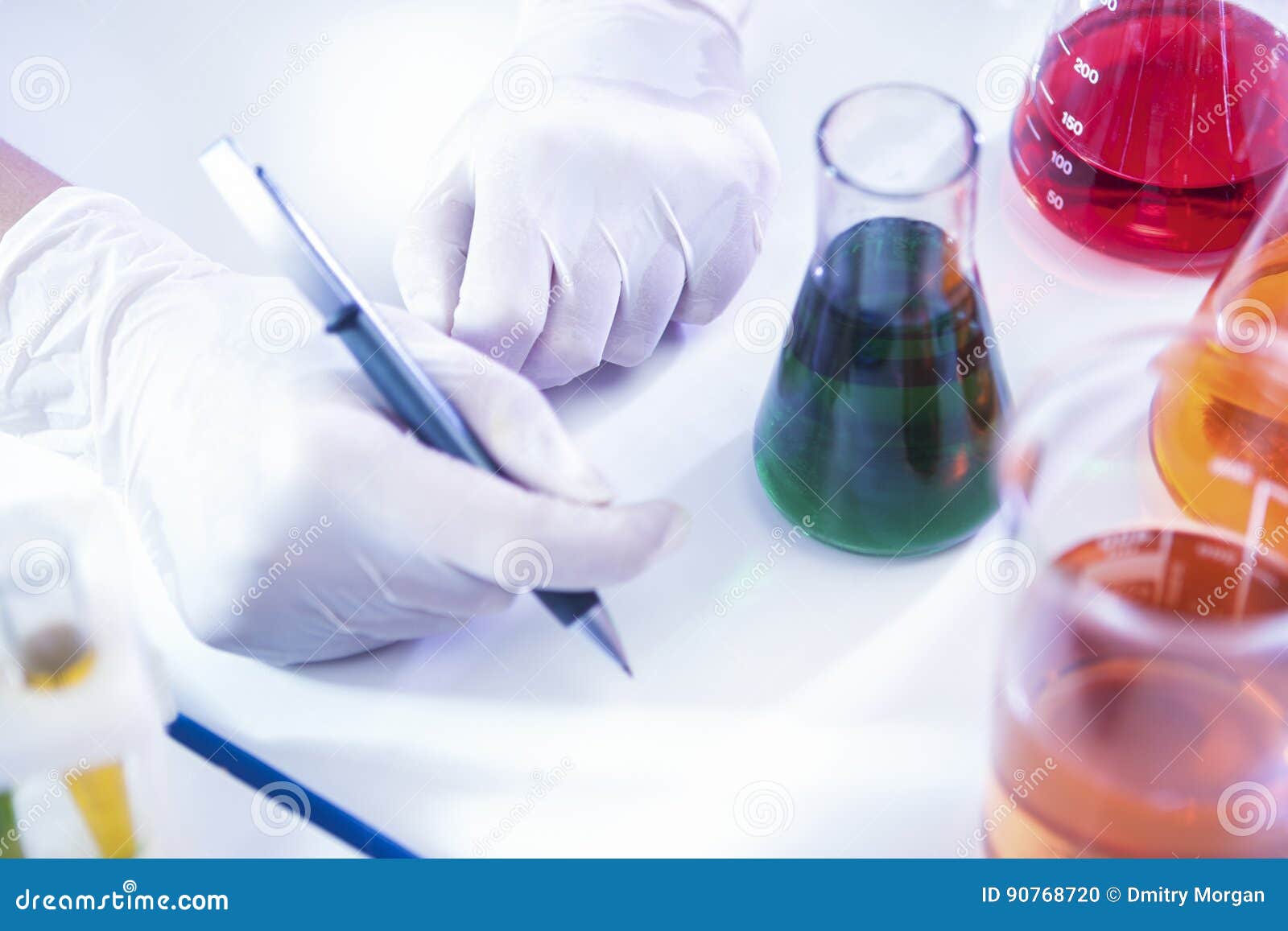 Female Laboratory Worker Dealing with Flasks Containing Liquid ...