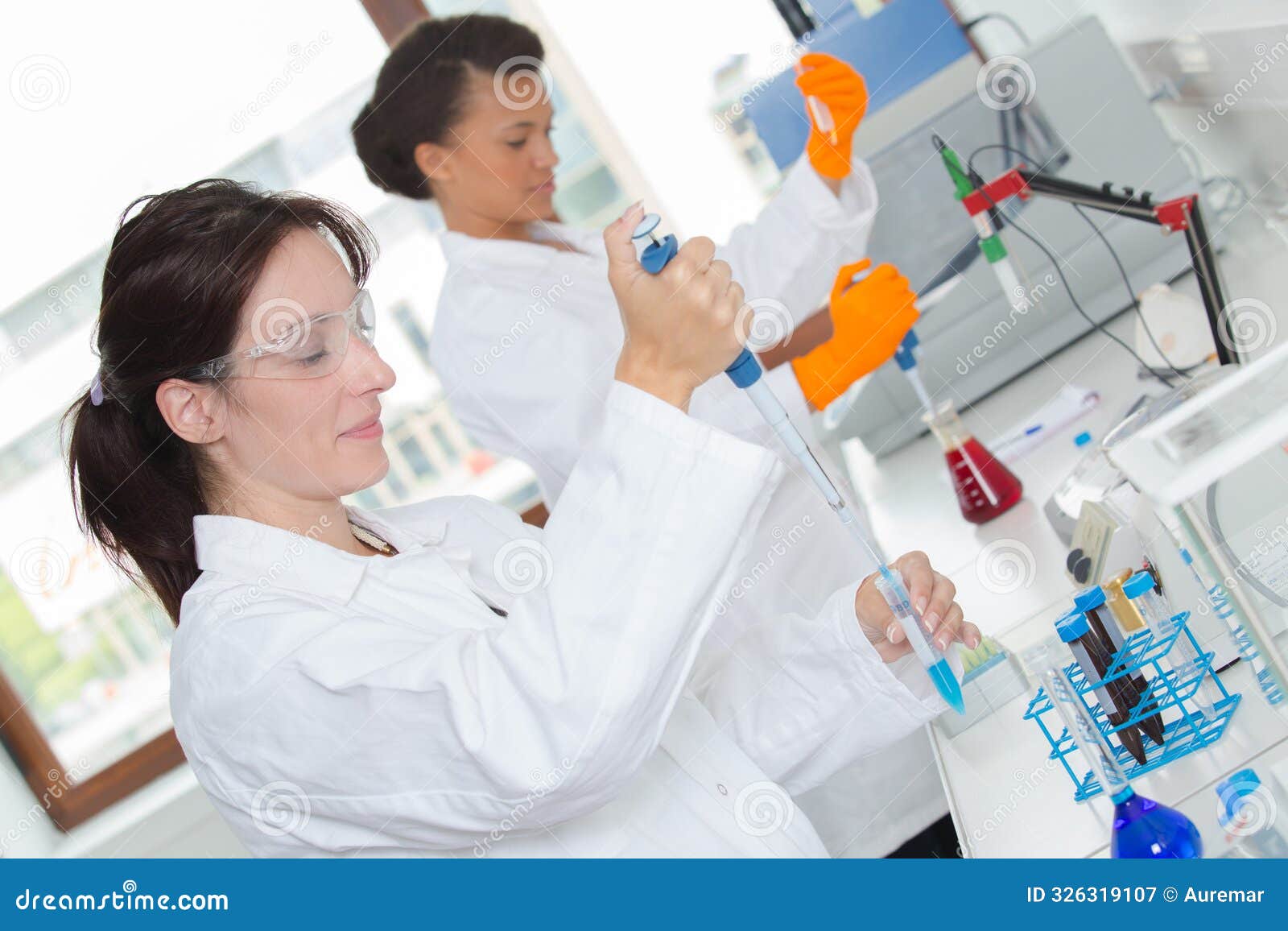 Female Lboratory Technicians Using Pipettes in Laboratory Stock Image ...