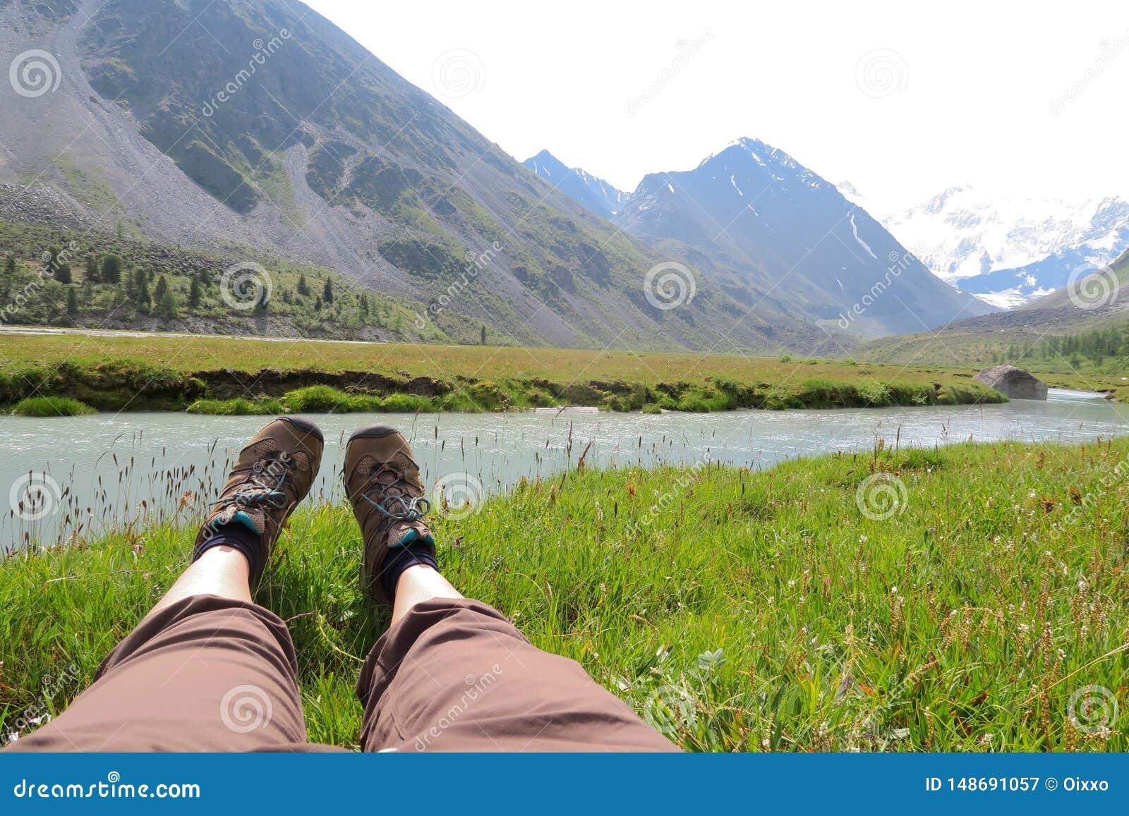 Female Legs on the Grass and Mountains Landscape on Background Stock ...