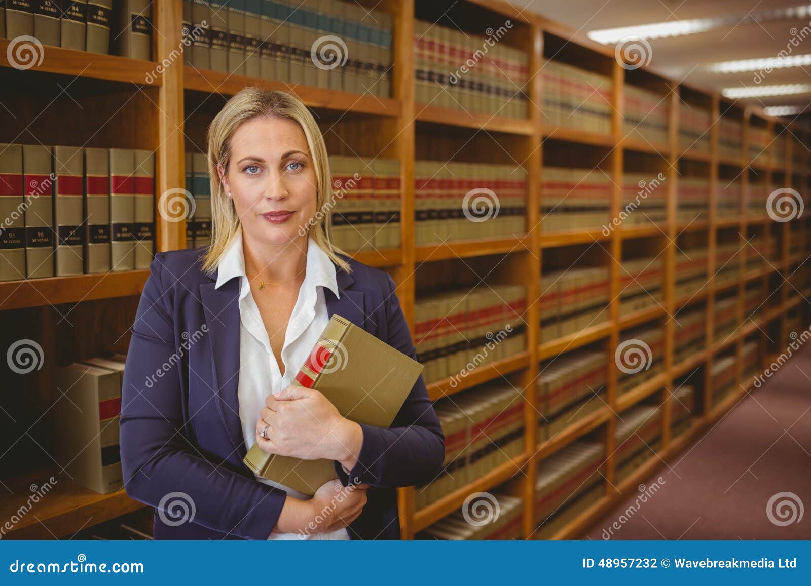 Female Librarian Posing and Holding a Book Stock Photo - Image of ...