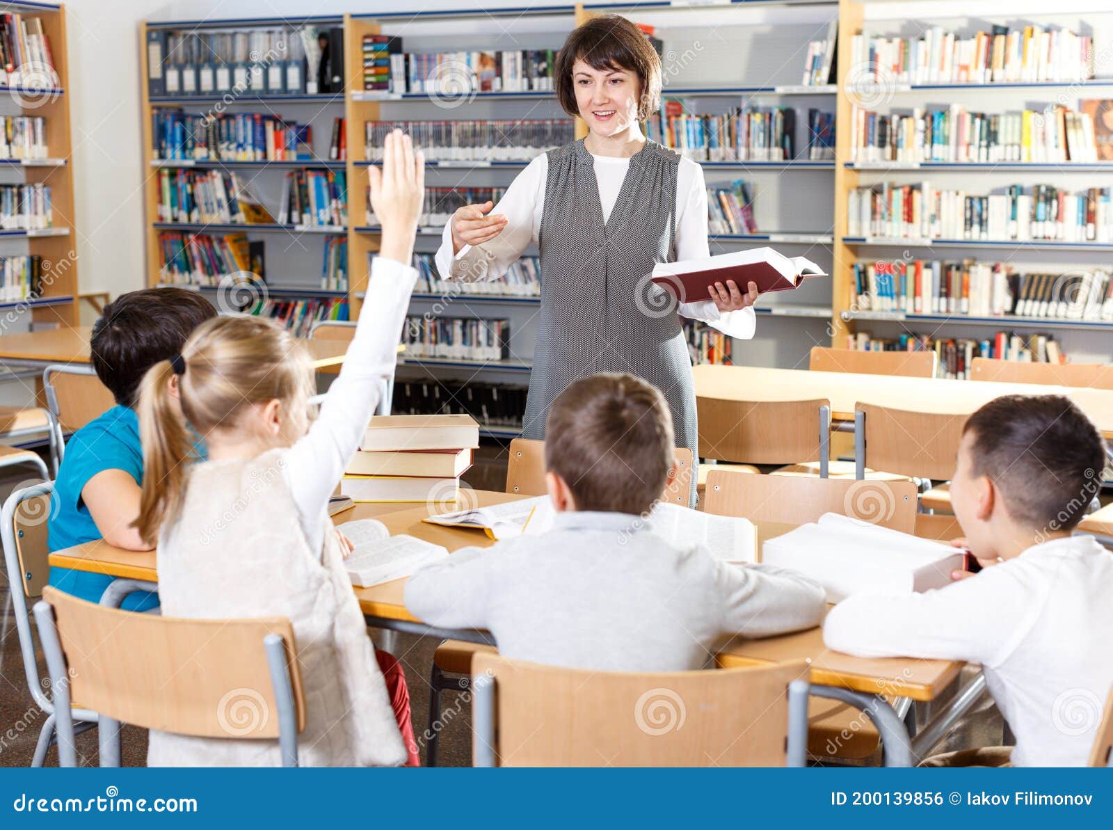 Female Librarian and Schoolkids during Classes Stock Photo - Image of ...