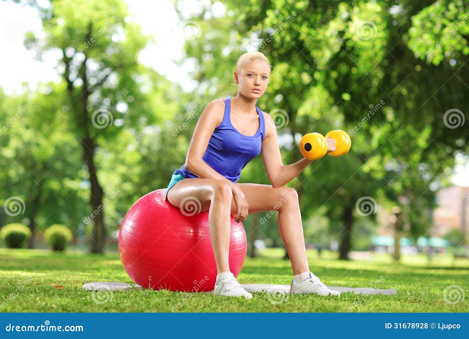 Female Lifting Weigth and Sitting on an Exercise Ball in Park Stock ...