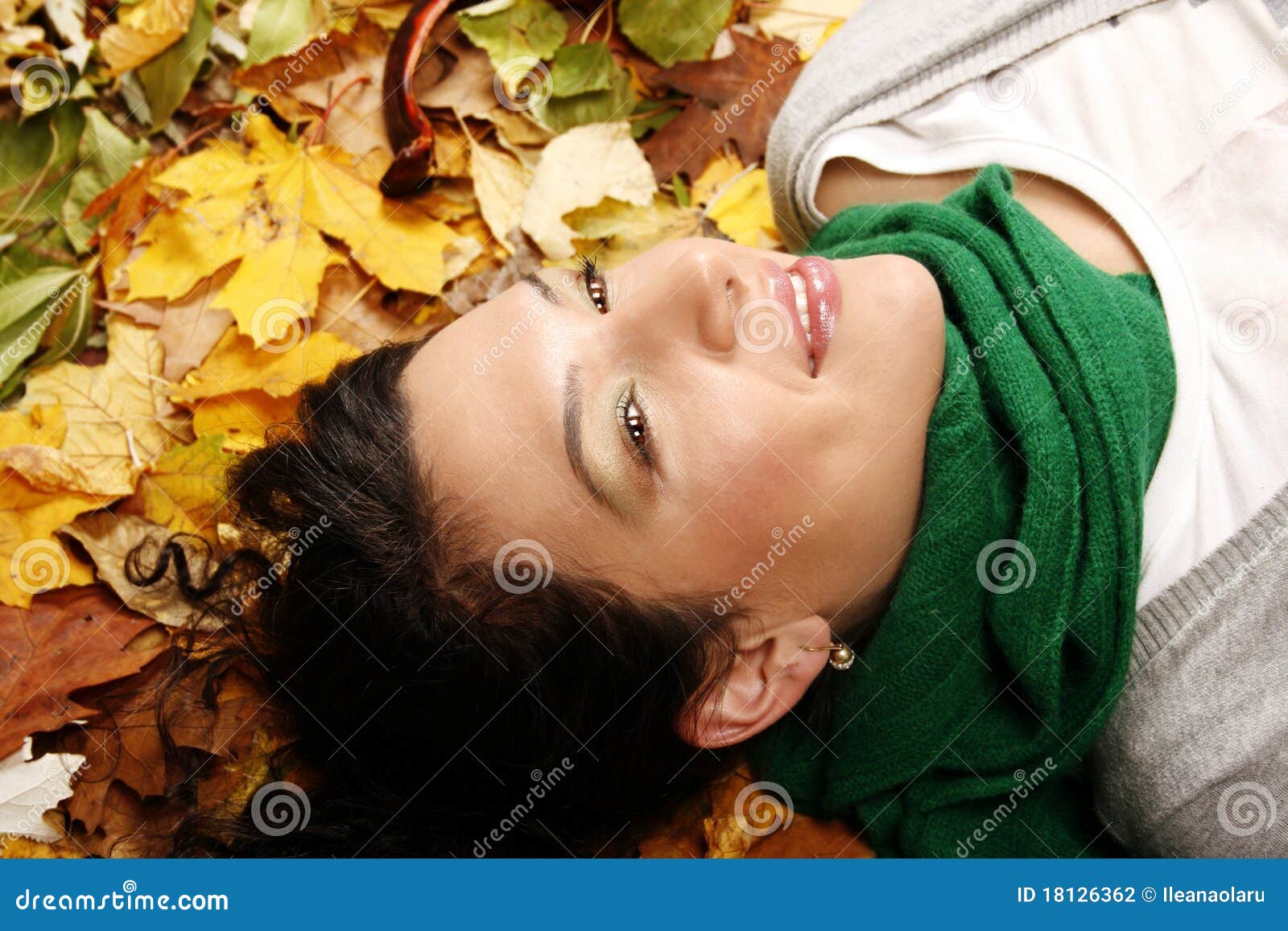 Female lying on the leaves stock photo. Image of maple - 18126362