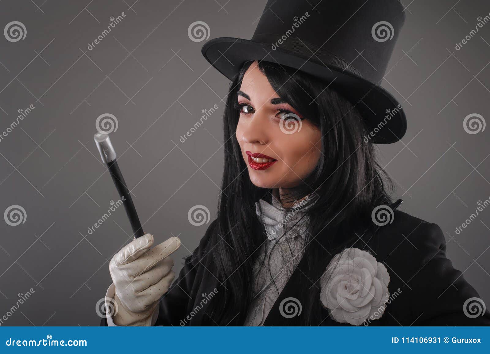 Female Magician in Costume Suit with Magic Stick Doing Trick Stock ...