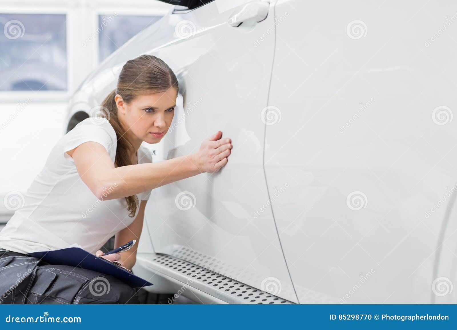 Female Maintenance Engineer Examining Car in Workshop Stock Photo ...