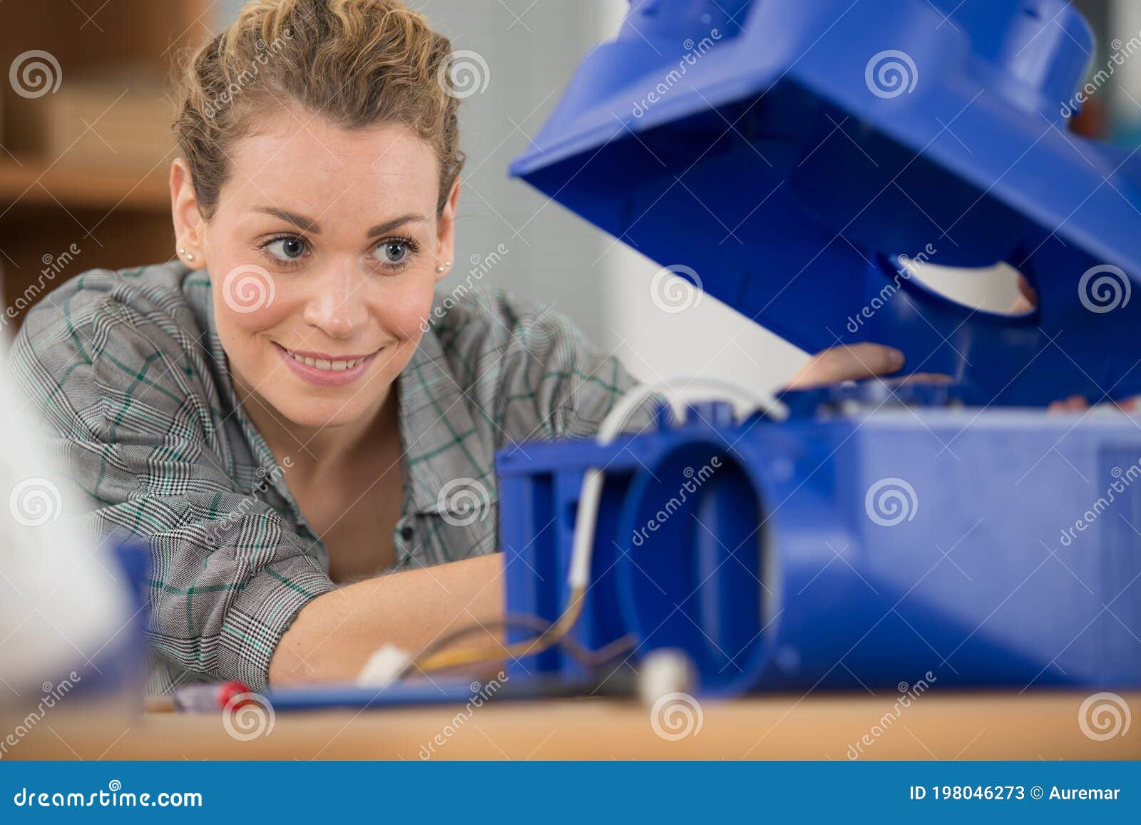 Female Maintenance Engineer Testing Voltage with Digital Multimeter ...