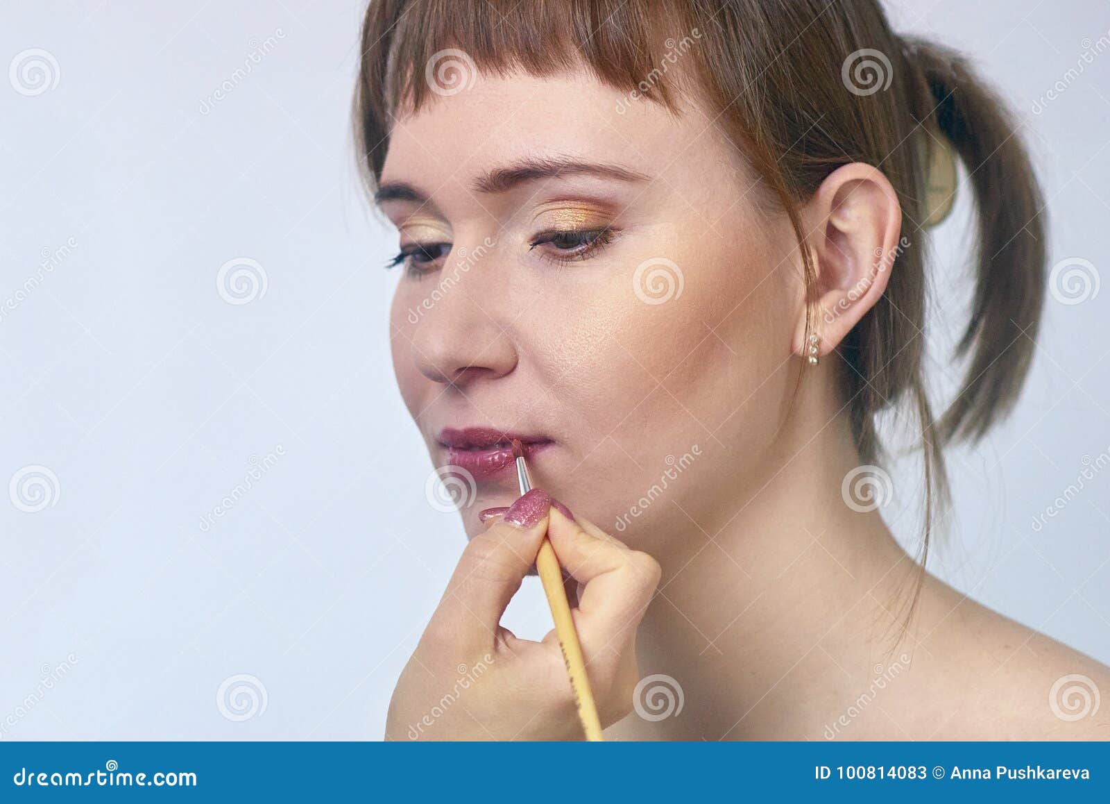 Female Makeup Model and Visagiste Hand with Lipstick Brush - Centered ...