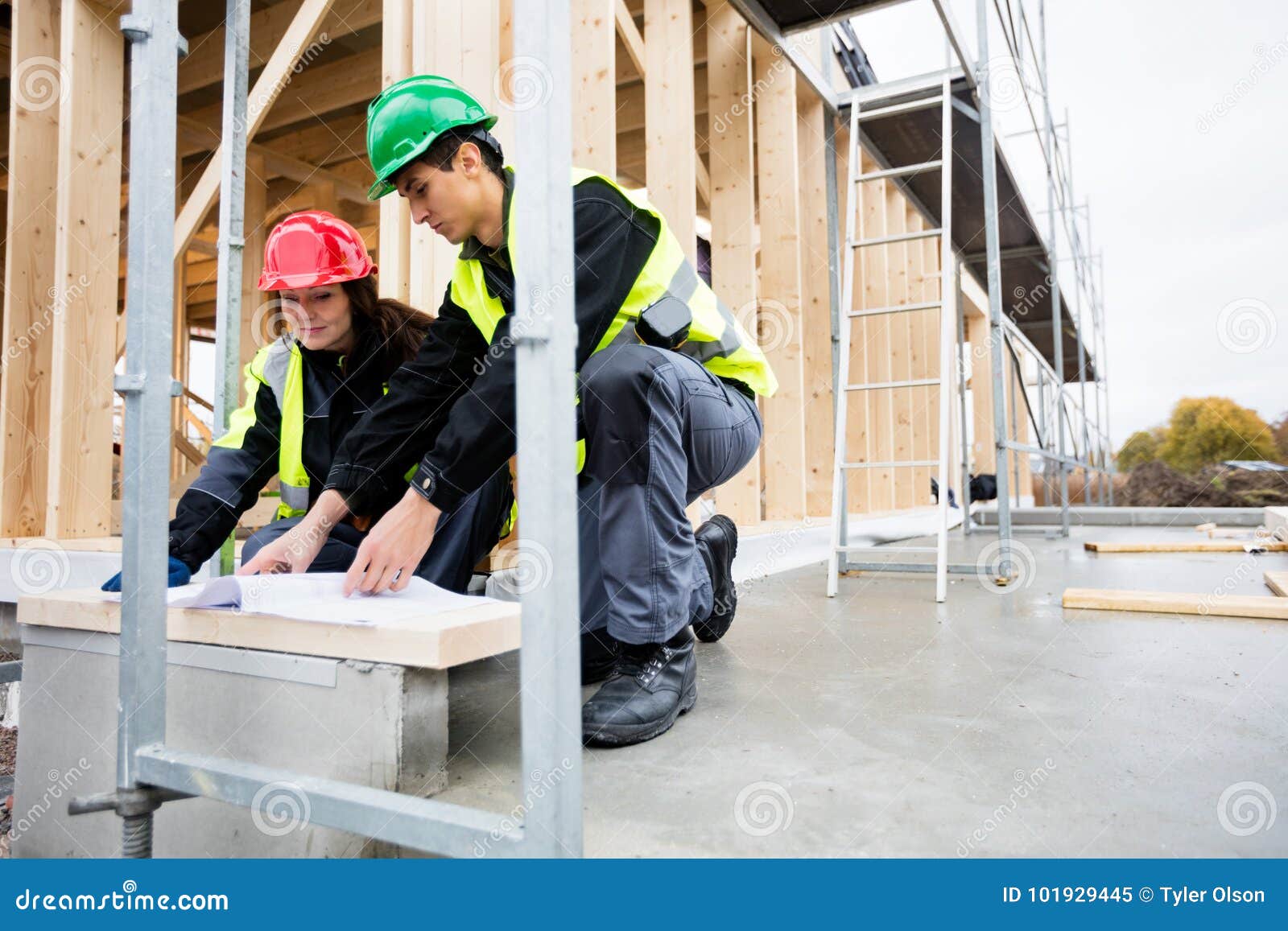 Carpenters Analyzing Document at Construction Site Stock Image - Image ...