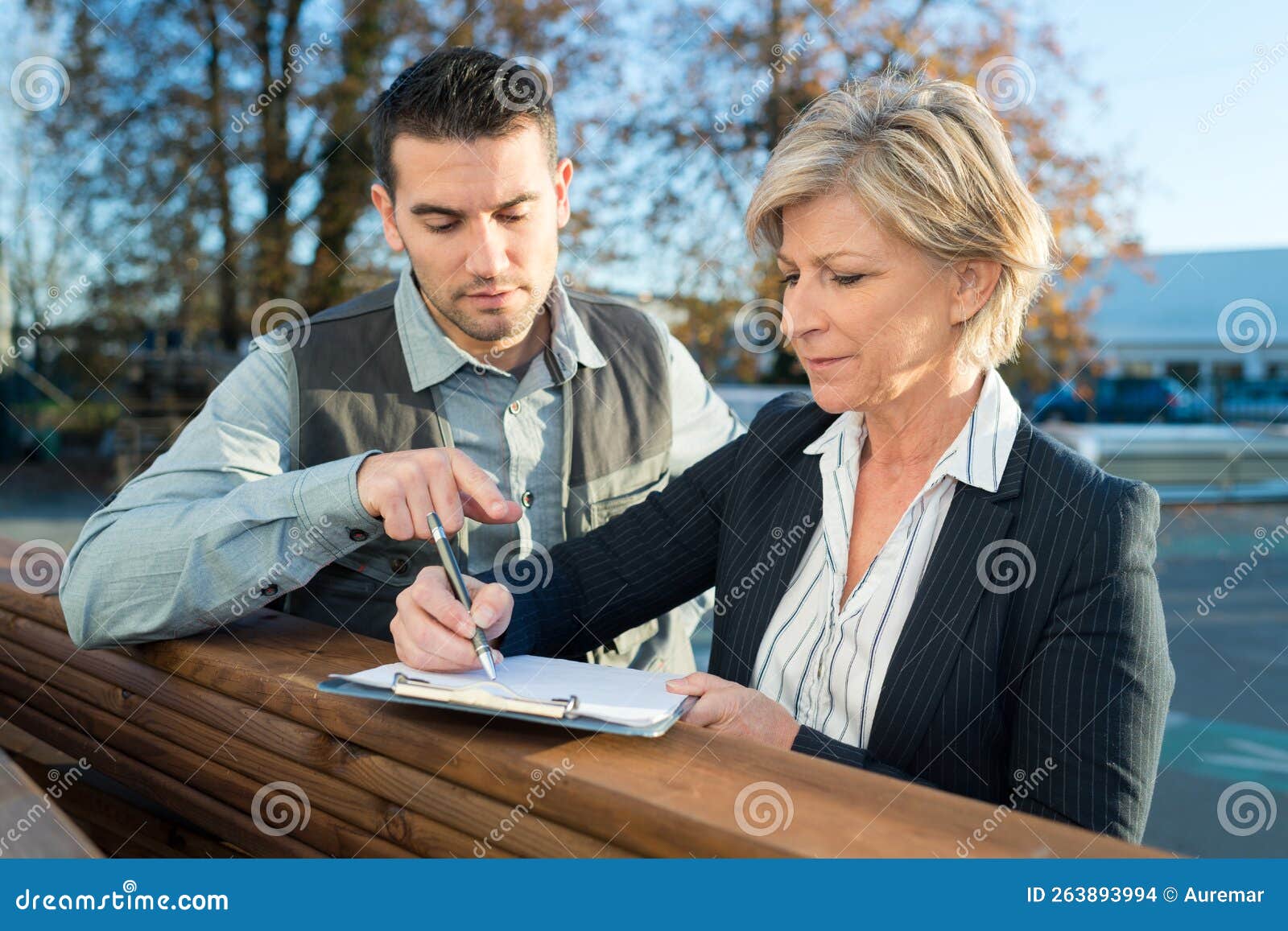 Female and Male Employee Writing Notes Outdoors Stock Photo - Image of ...