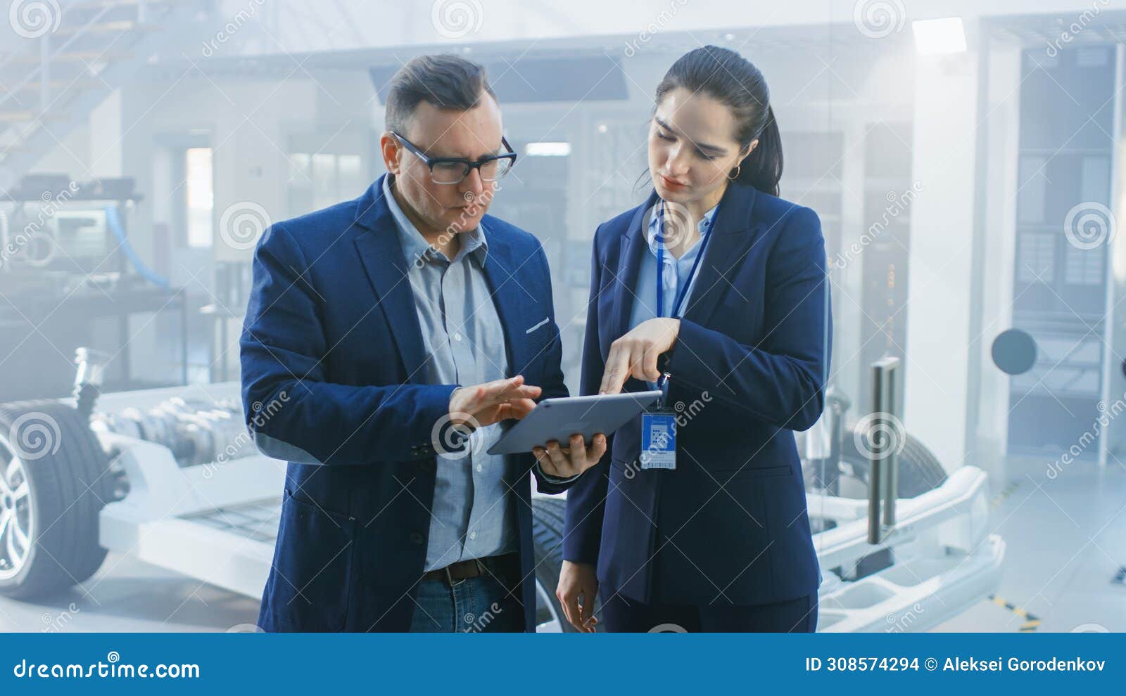 Female and Male Engineer Work in a High Tech Development Facility ...