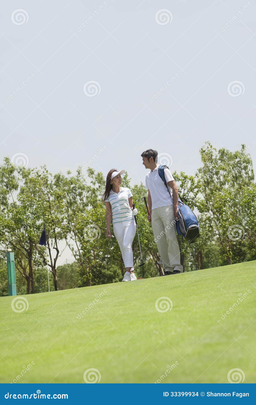 Female and Male Golfers Talking and Walking on the Golf Course Stock ...