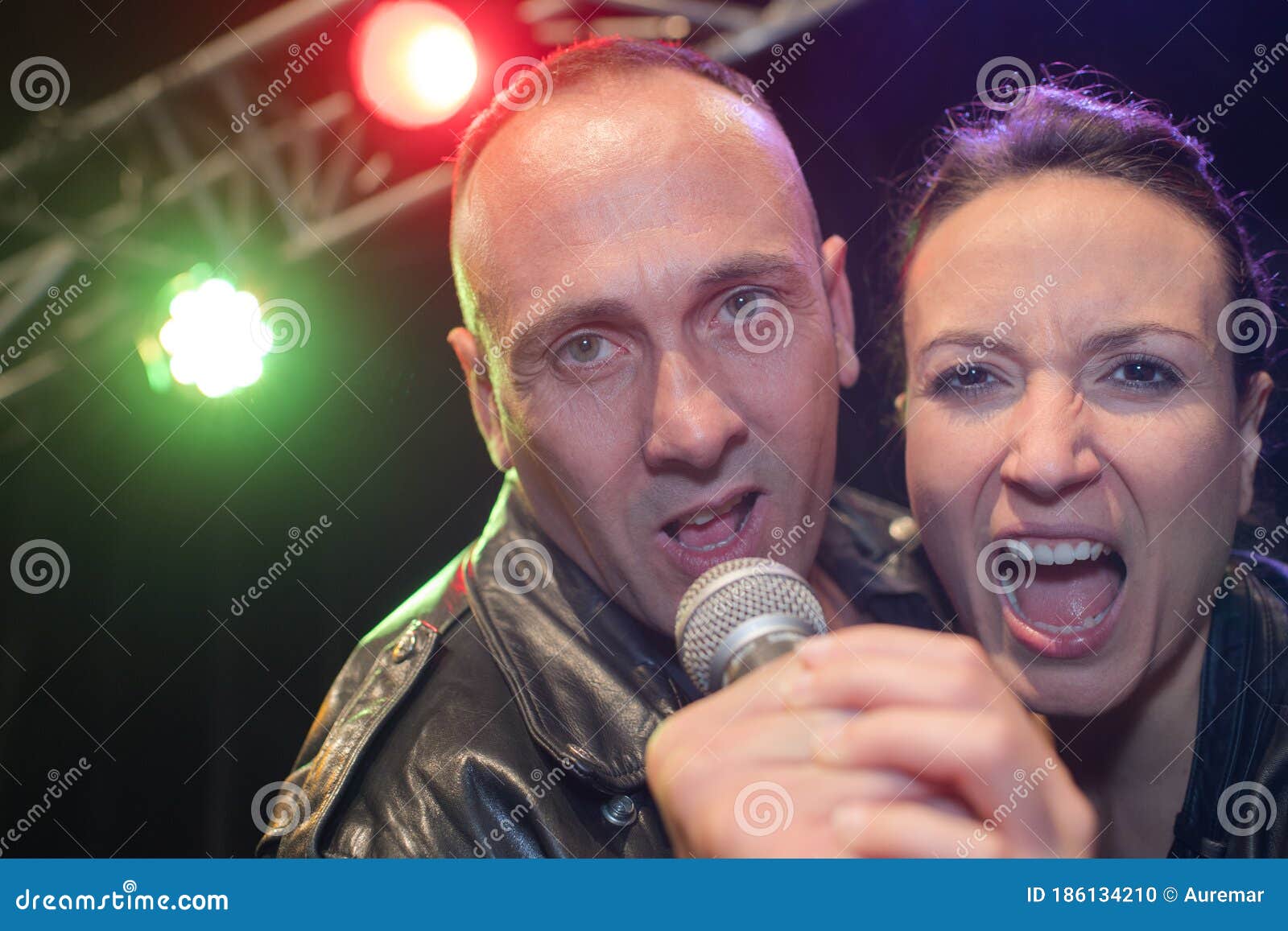 Female and Male Singers Sharing Microphone Stock Photo - Image of ...
