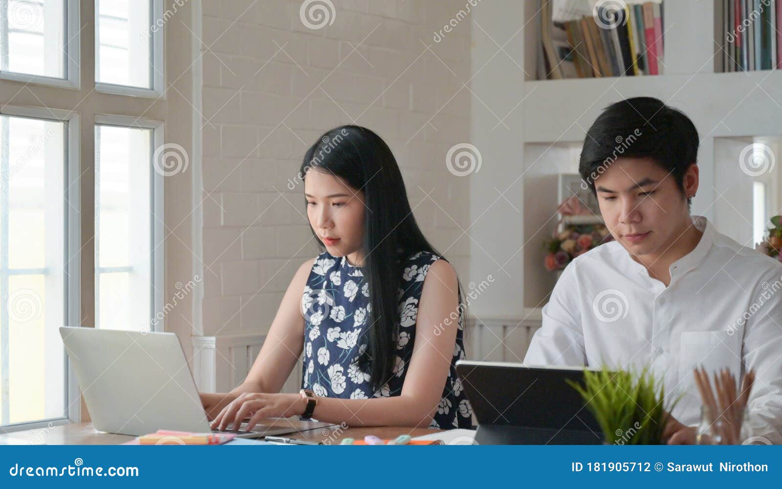 Female and Male Students are Using Laptops To Study Summer Online at ...