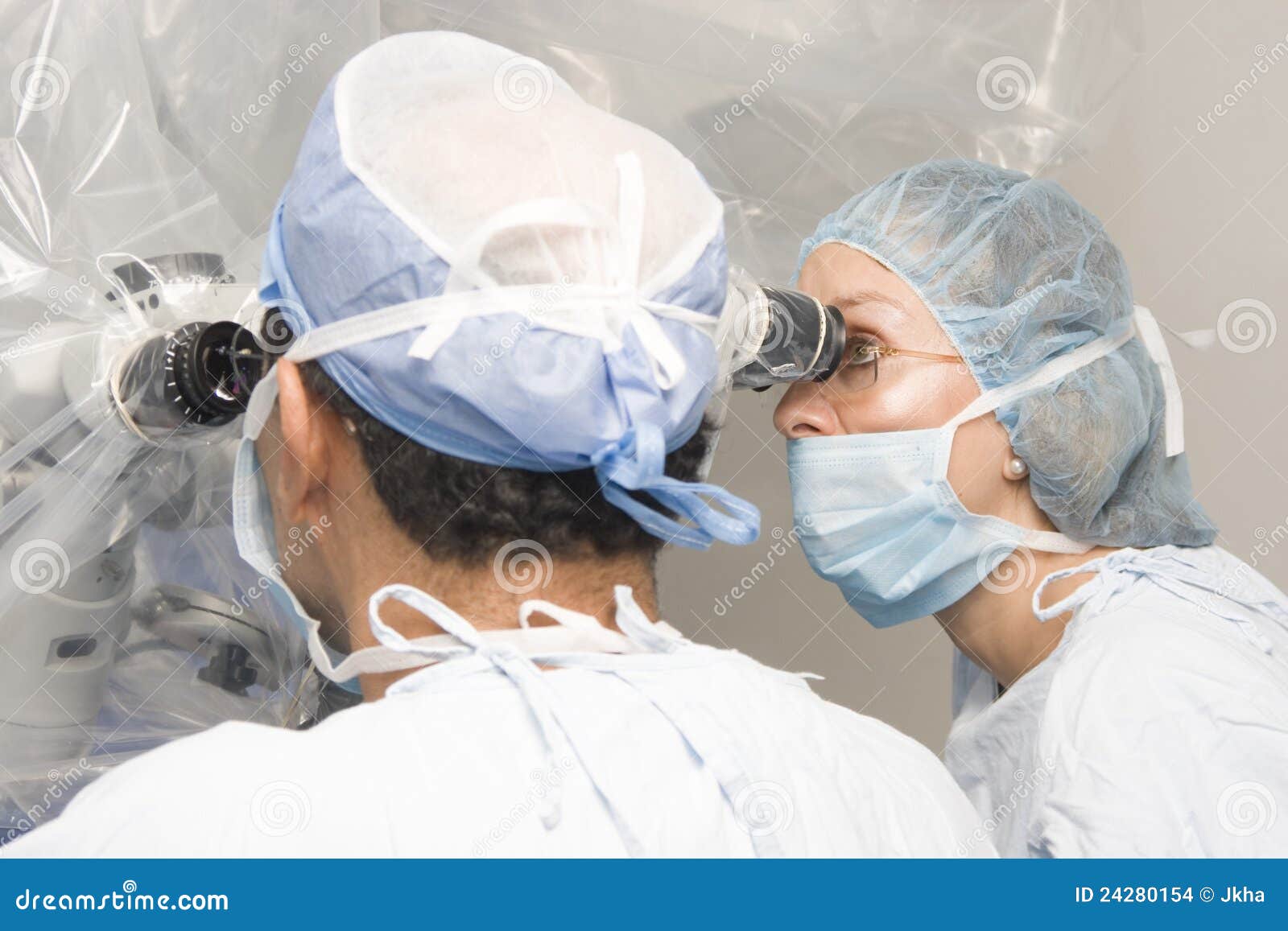 Surgeons Using Surgical Instruments For Keyhole Surgery, Watching The ...
