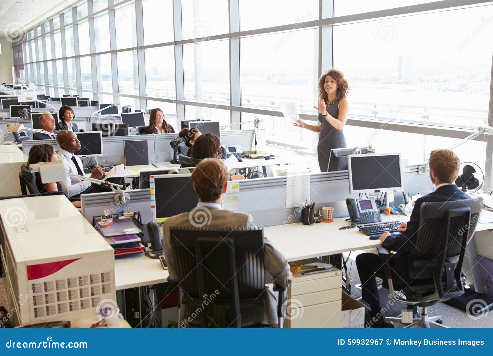 Female Manager Addressing Workers in Open Plan Office Stock Image ...