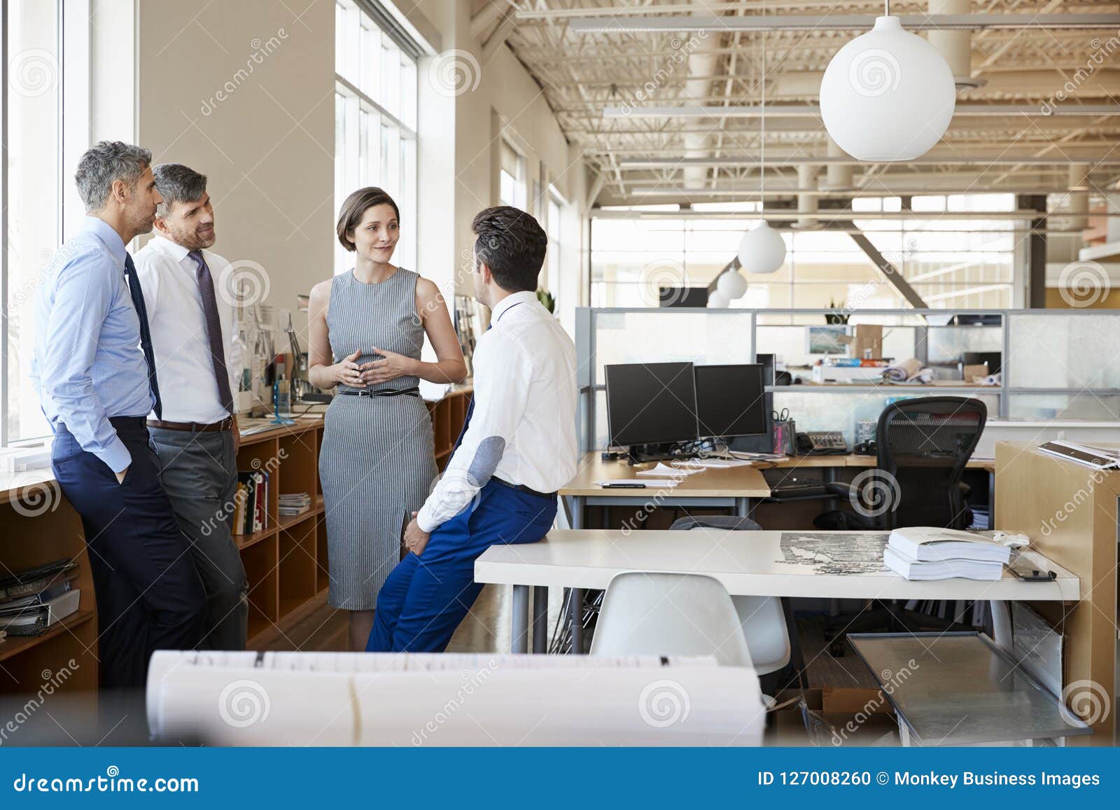 Female Manager and Colleagues Talking in an Open Plan Office Stock ...
