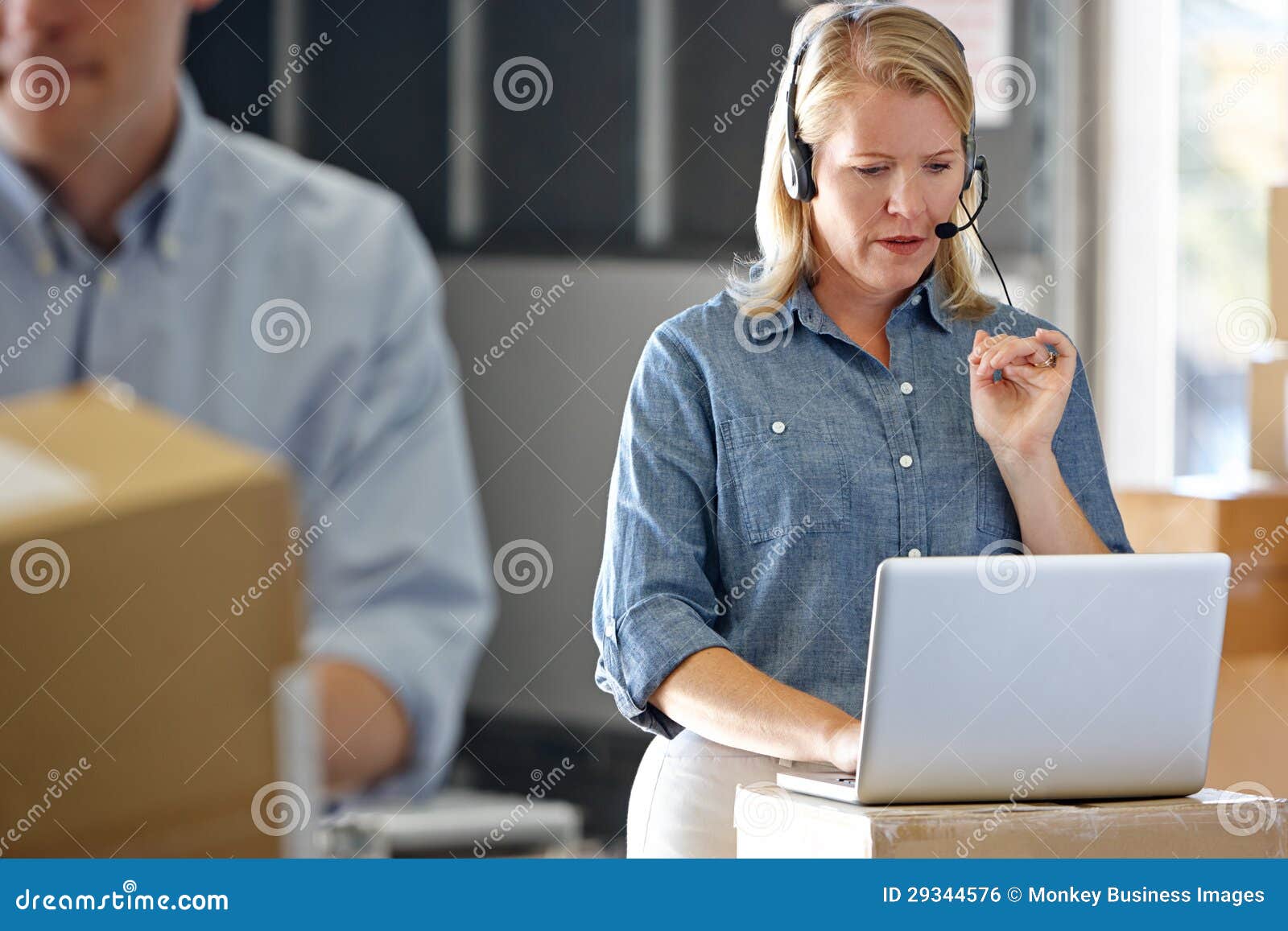Female Manager Using Headset in Distribution Warehouse Stock Photo ...