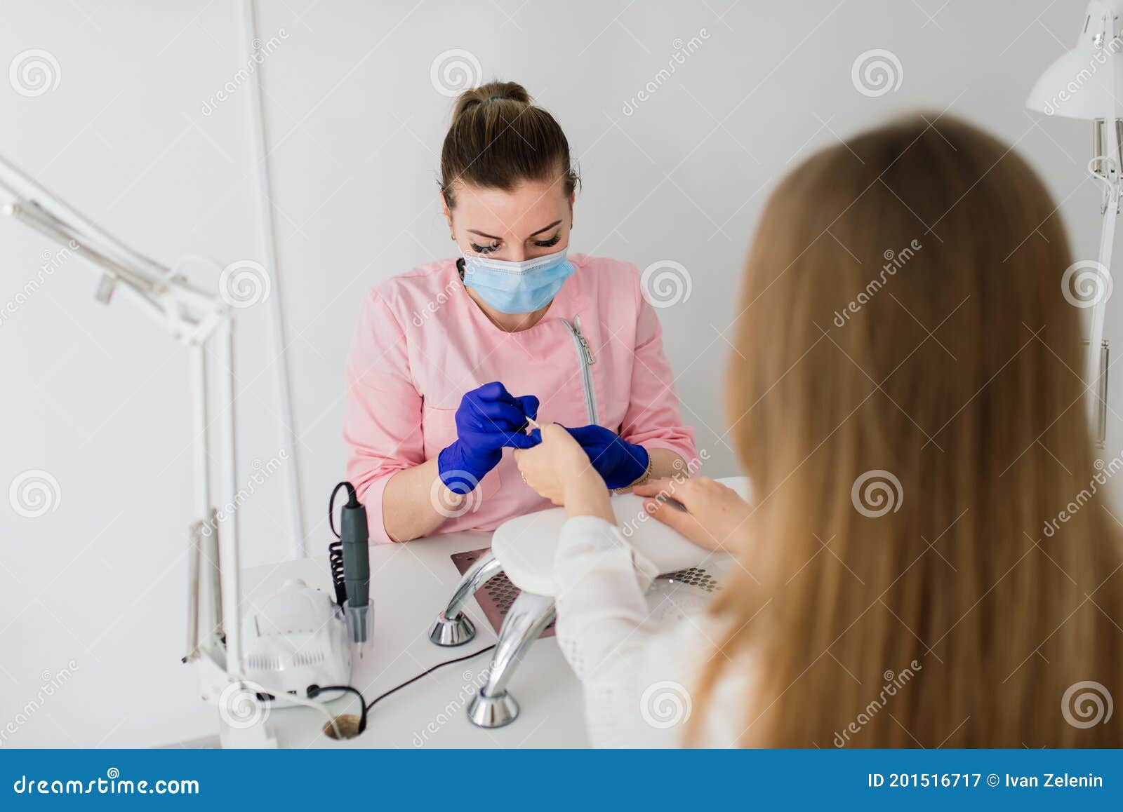 Female Manicure Master in a Beauty Salon Work with Hands of the Client ...