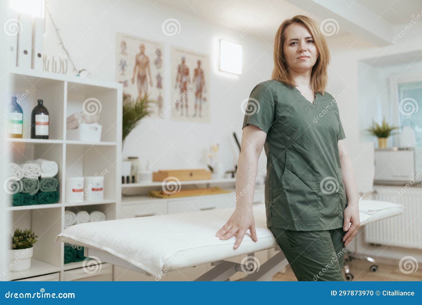Female Massage Therapist In Massage Cabinet Looking At Camera Stock