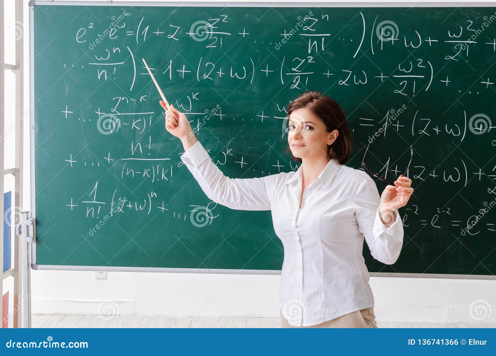The Female Math Teacher in Front of the Chalkboard Stock Photo - Image ...