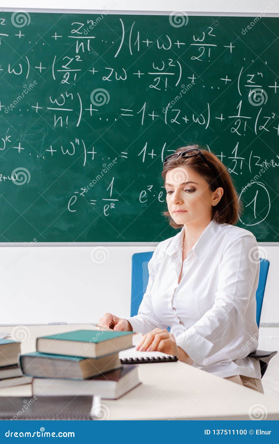 The Female Math Teacher in Front of the Chalkboard Stock Photo - Image ...