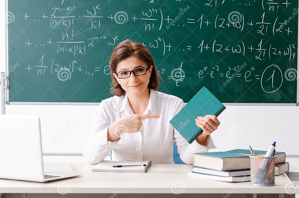 The Female Math Teacher in Front of the Chalkboard Stock Photo - Image ...