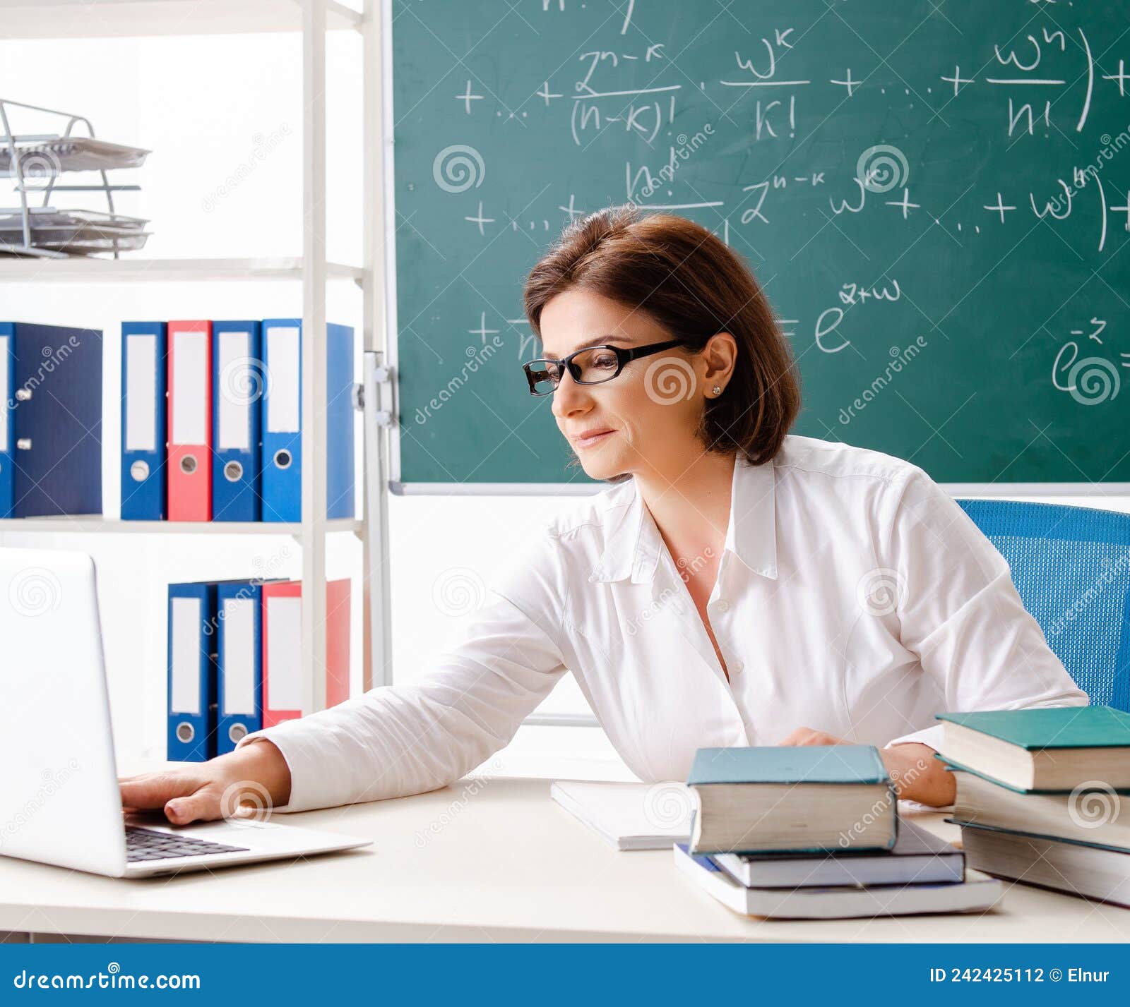 The Female Math Teacher in Front of the Chalkboard Stock Photo - Image ...