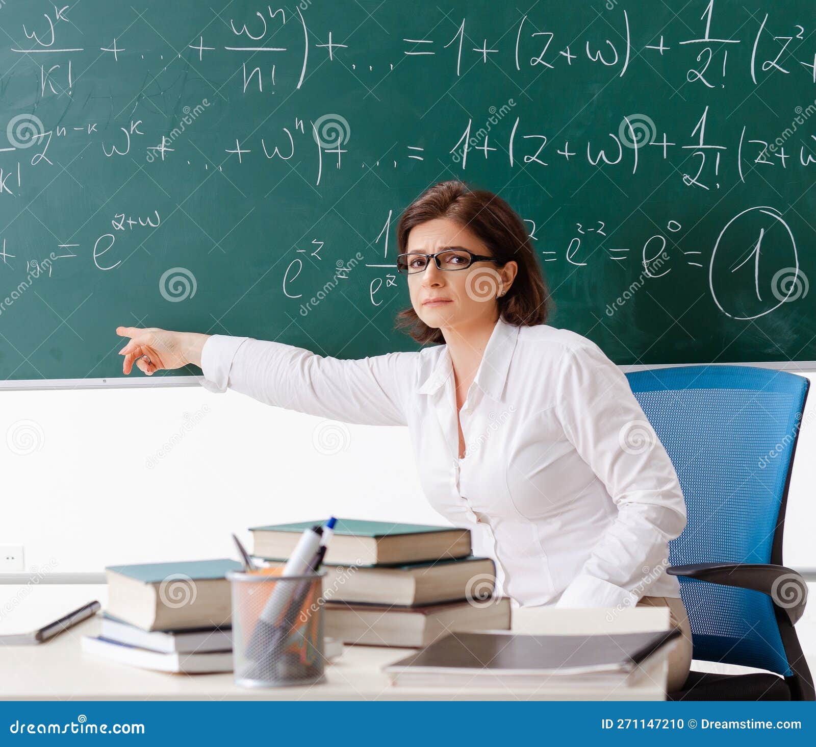 Female Math Teacher in Front of the Chalkboard Stock Photo - Image of ...
