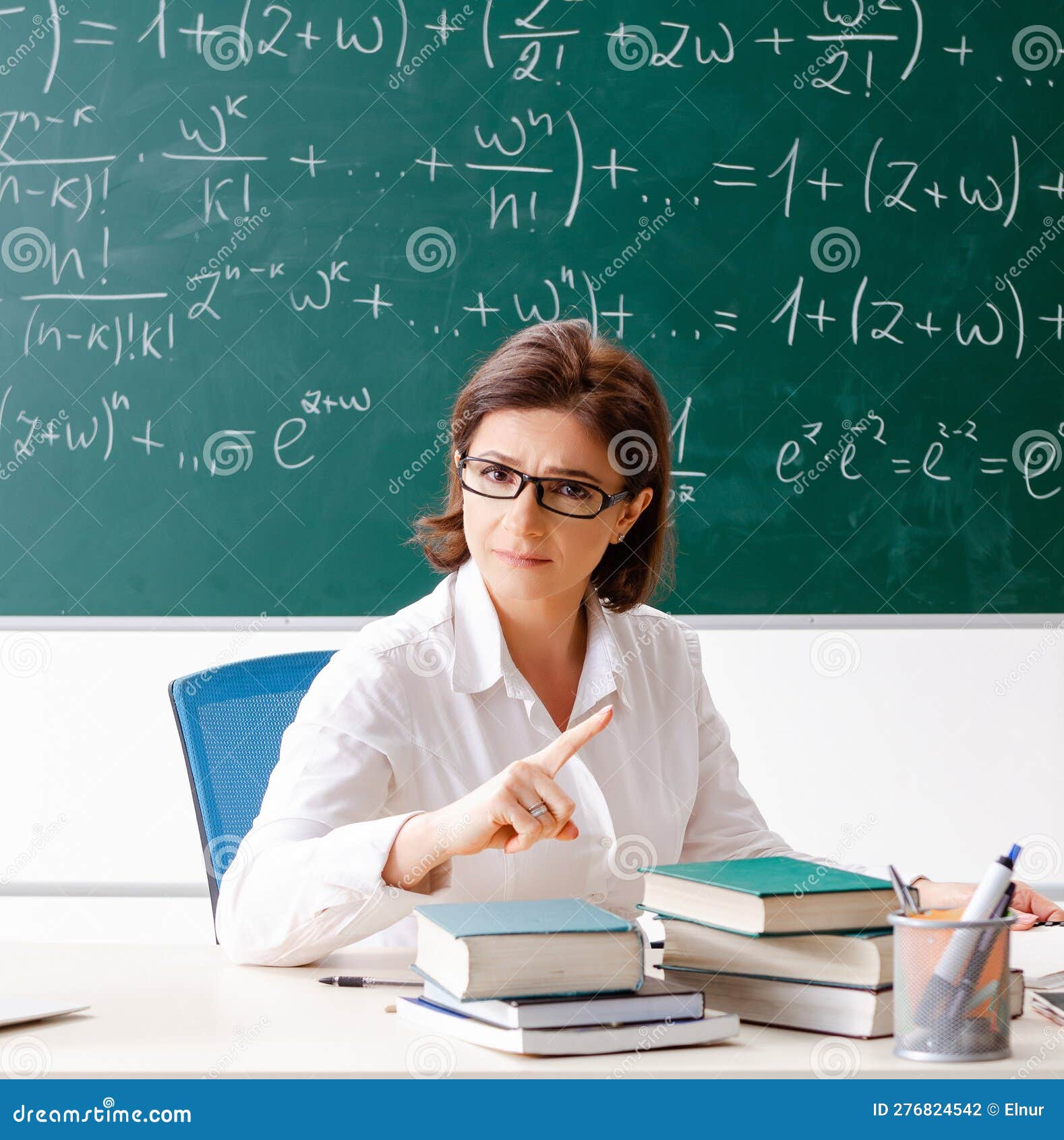 Female Math Teacher in Front of the Chalkboard Stock Photo - Image of ...