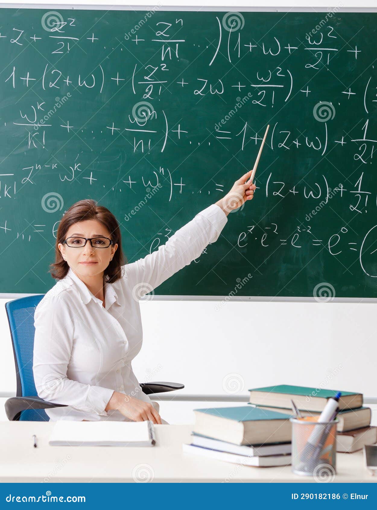 Female Math Teacher in Front of the Chalkboard Stock Photo - Image of ...