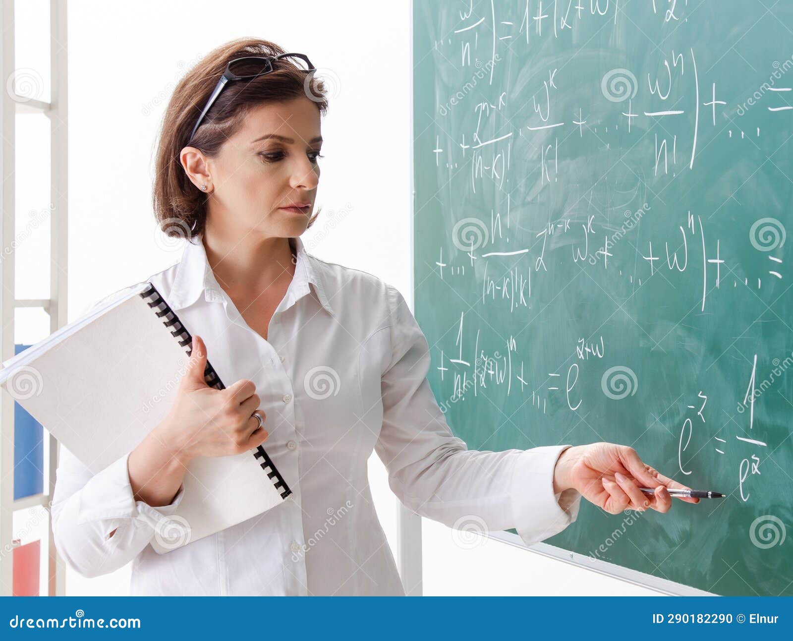 Female Math Teacher in Front of the Chalkboard Stock Photo - Image of ...