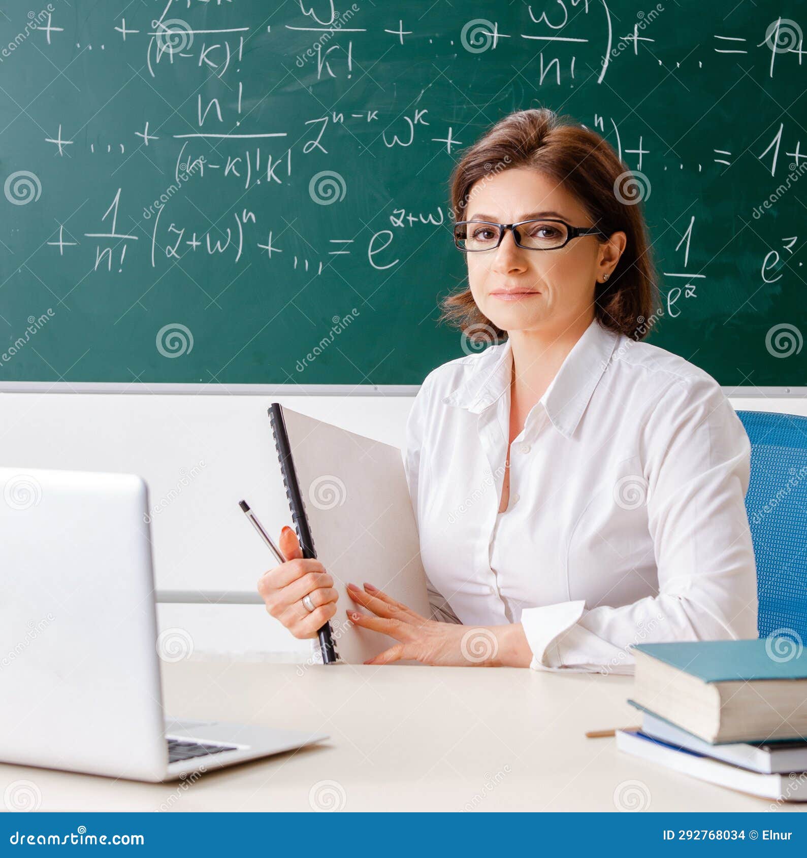 Female Math Teacher in Front of the Chalkboard Stock Photo - Image of ...