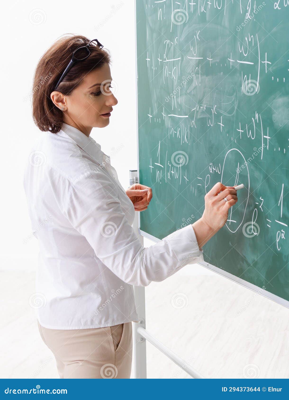 Female Math Teacher in Front of the Chalkboard Stock Photo - Image of ...