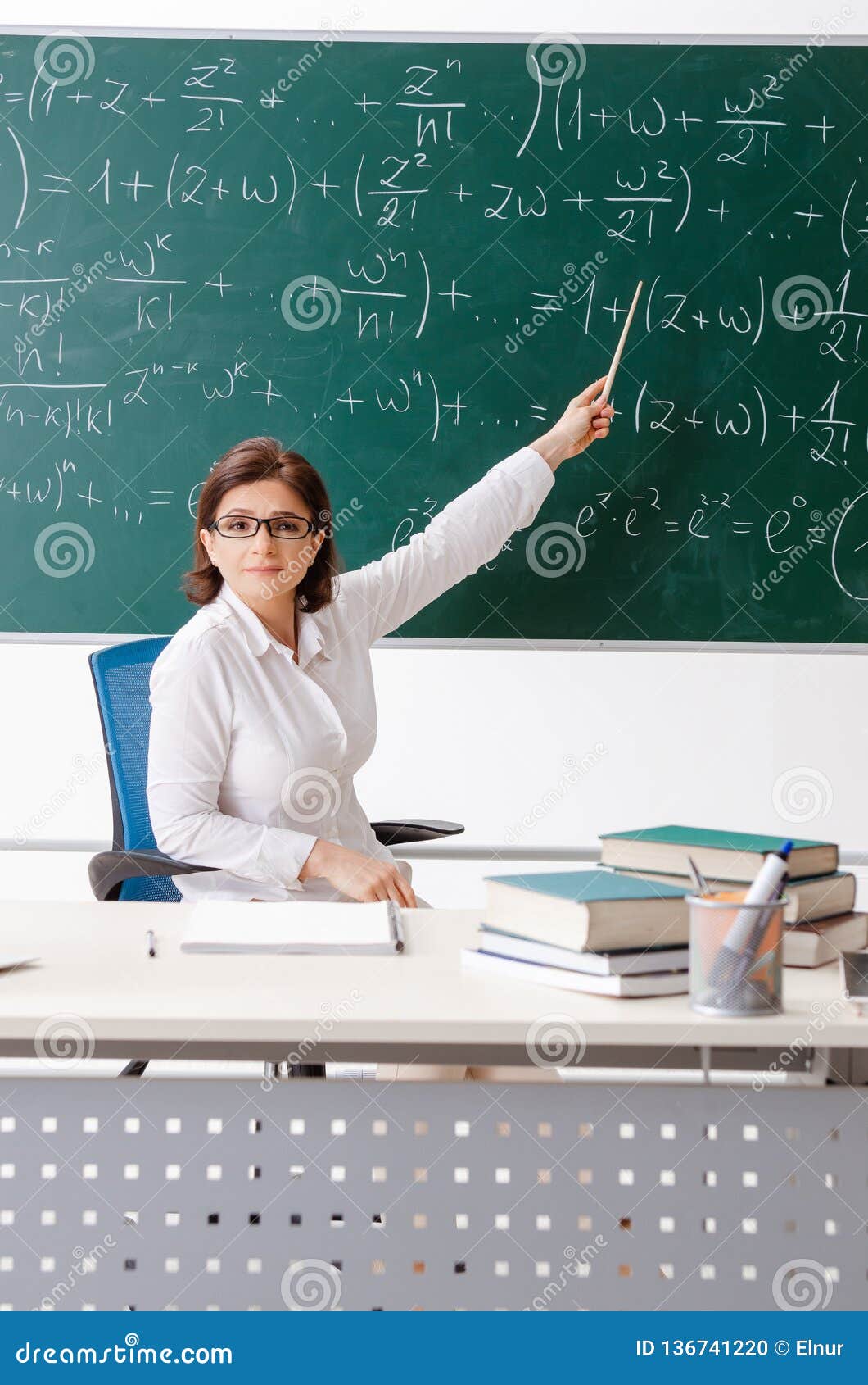 The Female Math Teacher in Front of the Chalkboard Stock Photo - Image ...