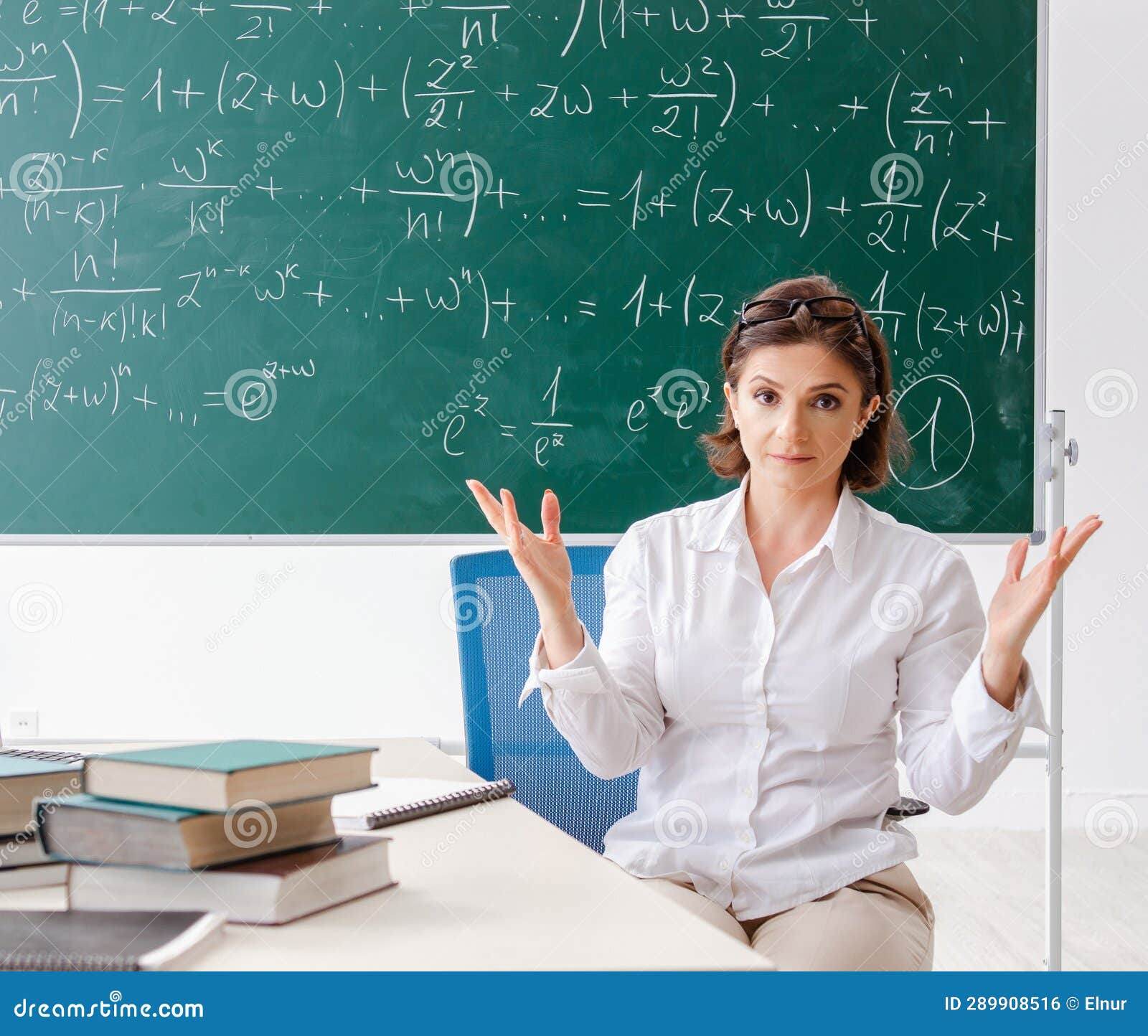 Female Math Teacher in Front of the Chalkboard Stock Photo - Image of ...