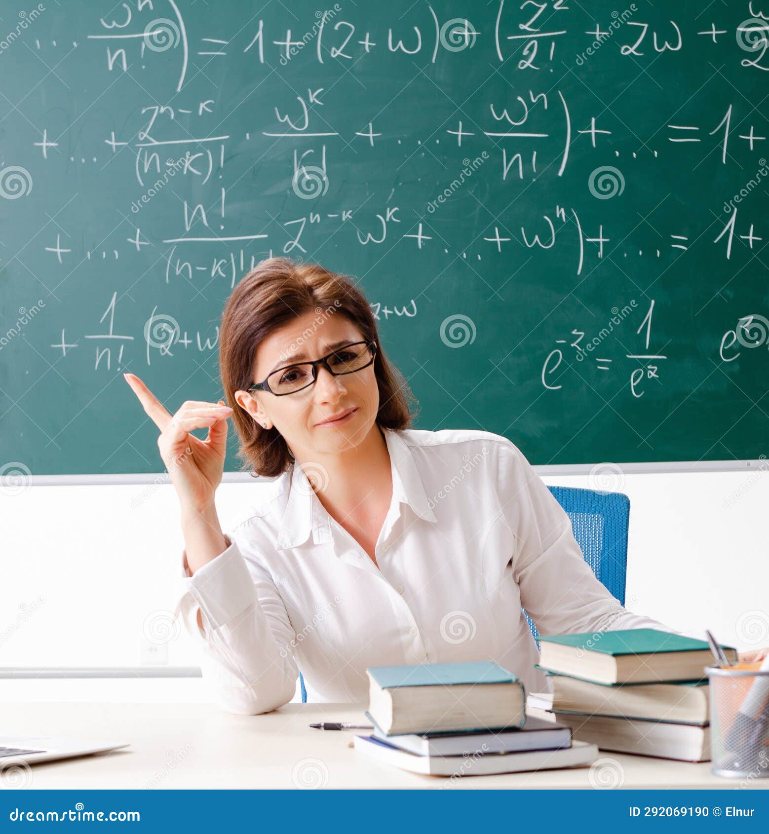 Female Math Teacher in Front of the Chalkboard Stock Photo - Image of ...