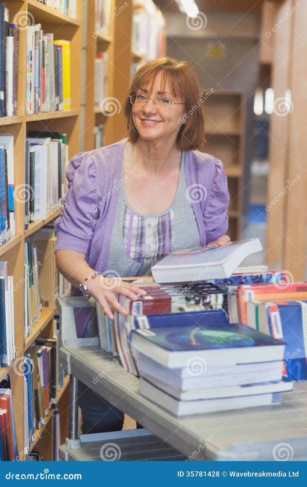 Female Mature Librarian Returning Books in Library Stock Photo - Image ...