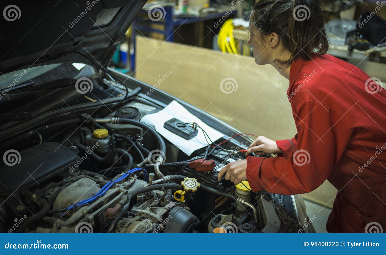Female Mechanic Testing Car Battery with Multimeter Tool Stock Image ...