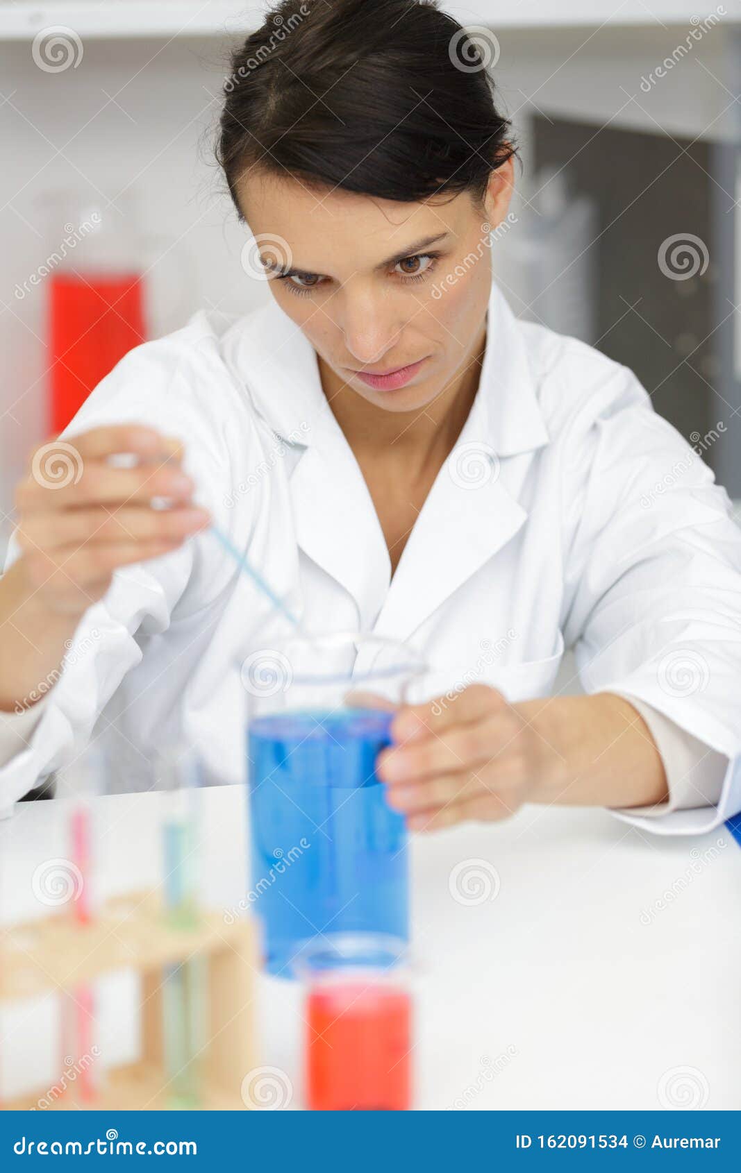 Female Mixing Blue Liquid in Beaker Stock Photo - Image of anasis ...