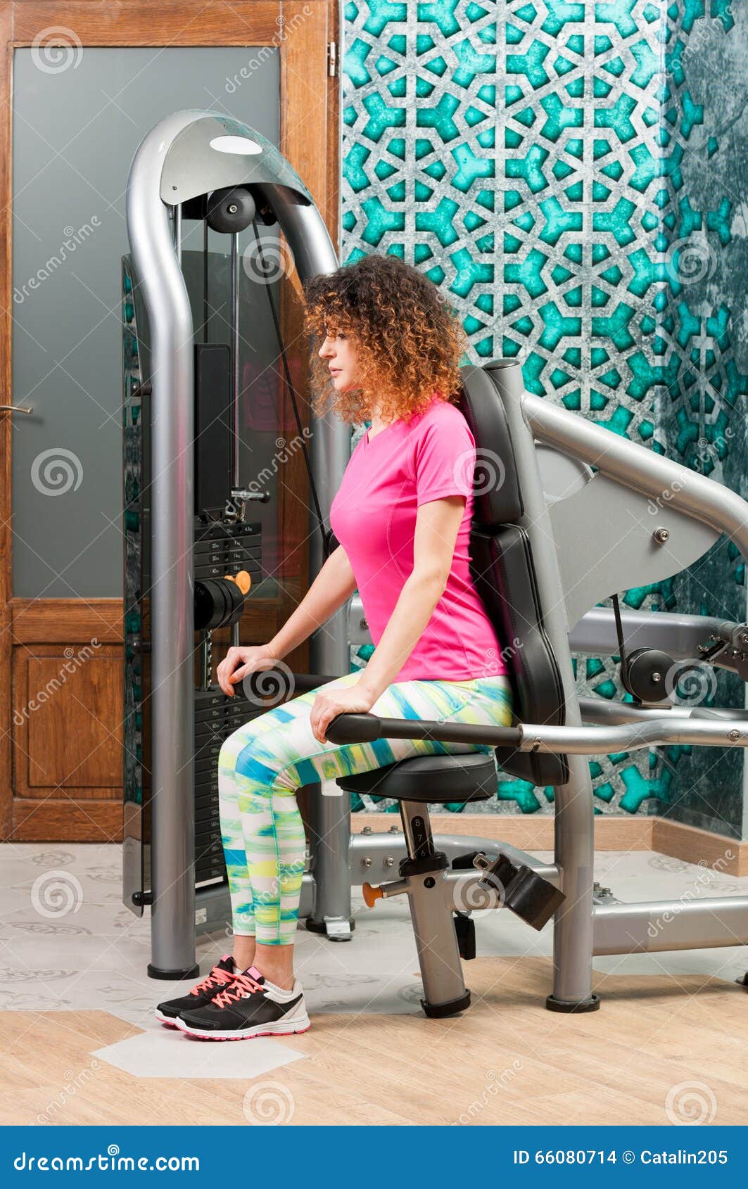 Female Model Pushing Down the Triceps Machine Stock Photo - Image of ...