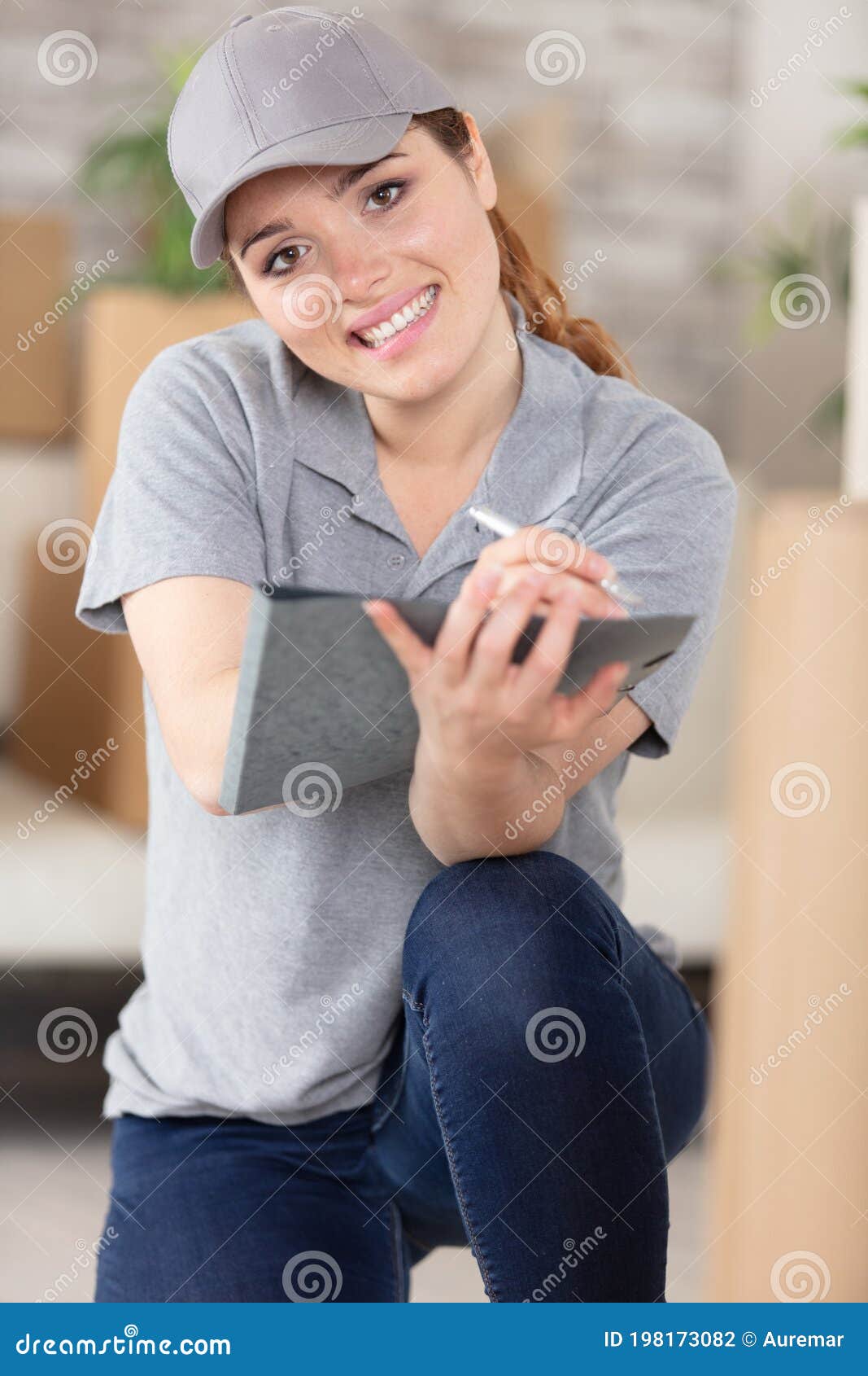 Female mover writing notes stock photo. Image of office - 198173082