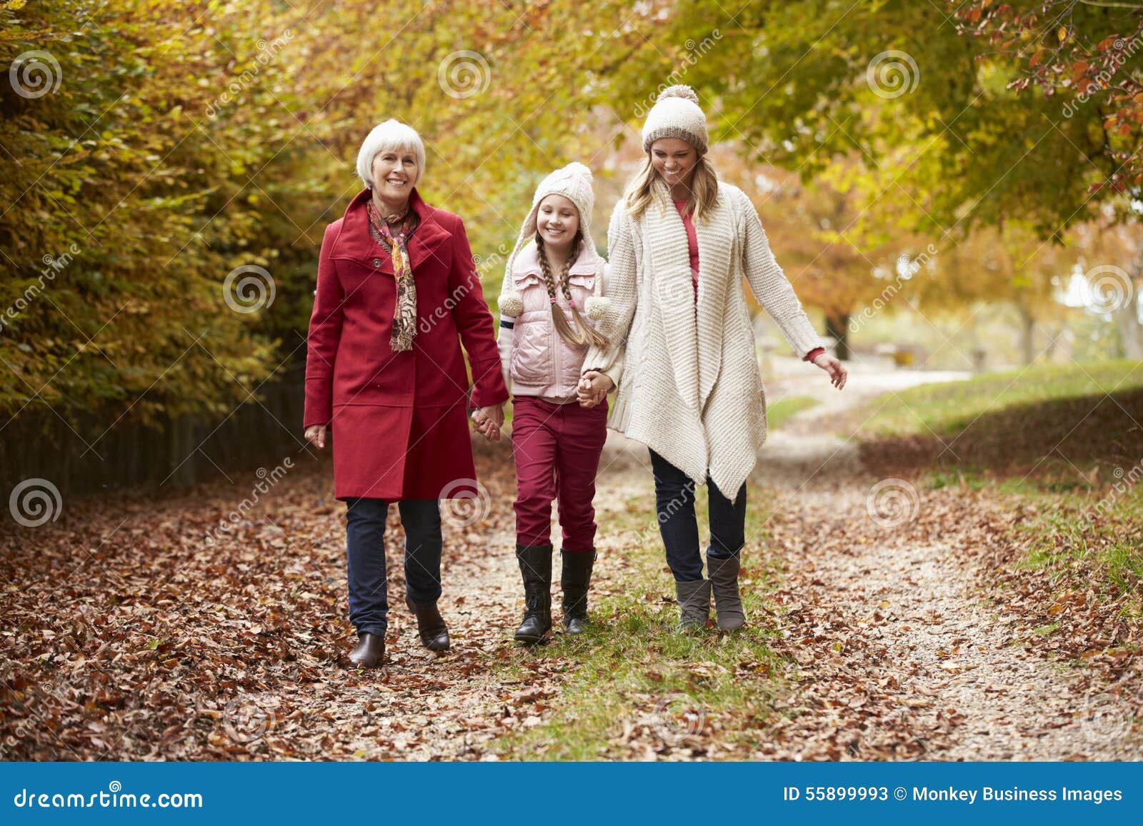 Female Multl Generation Family Walking Along Autumn Path Stock Image ...