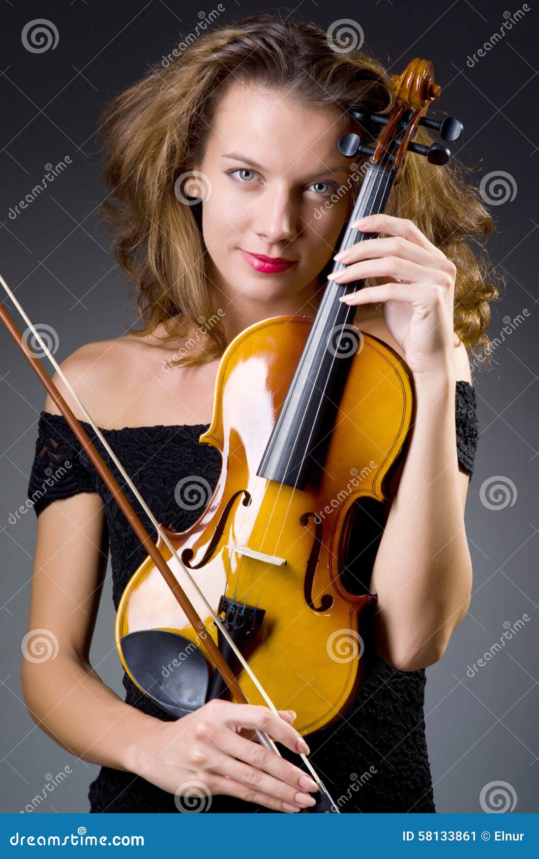 Female Musical Player Against Dark Background Stock Image - Image of ...