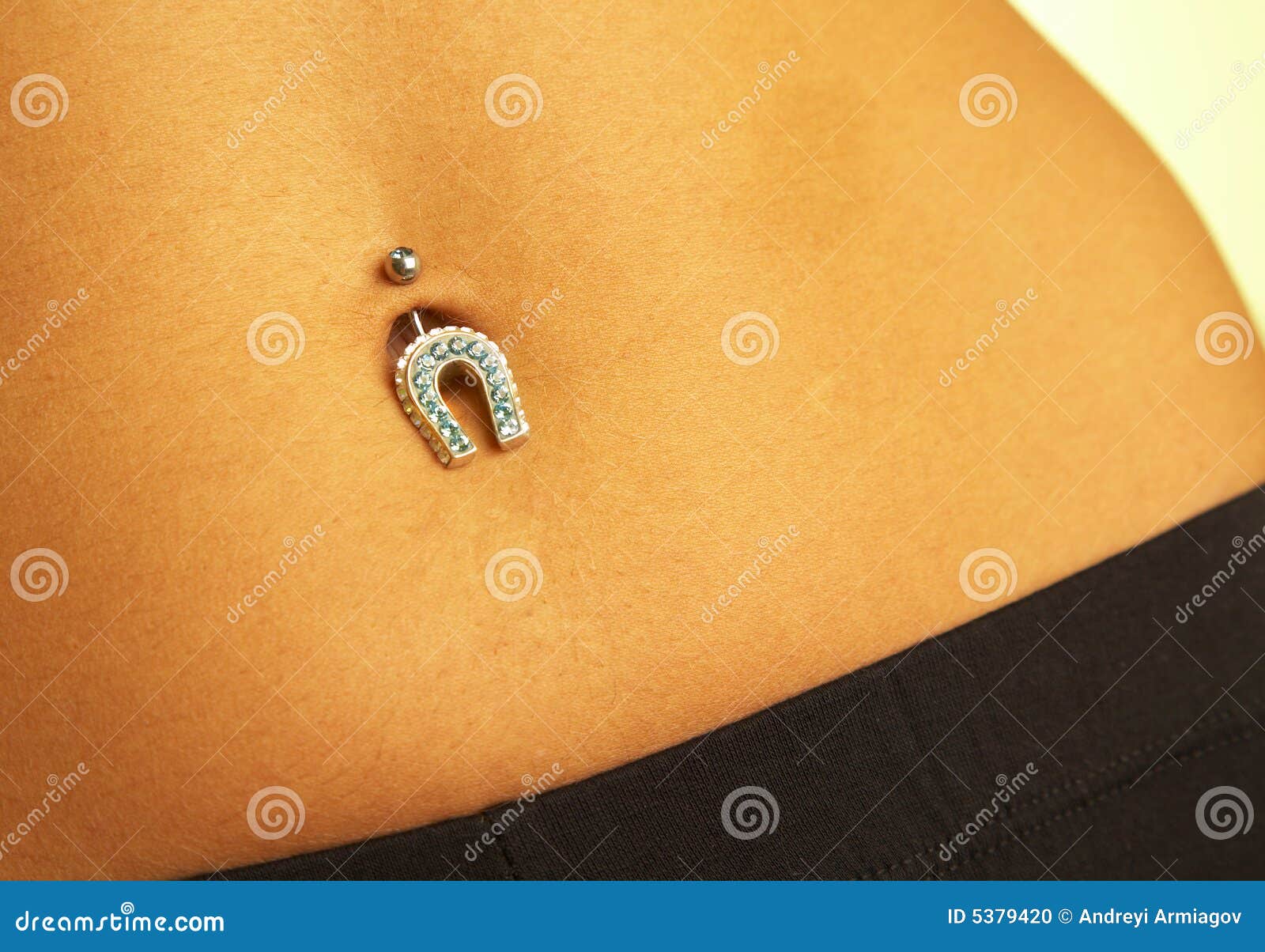 Female navel with piercing stock photo. Image of button - 5379420