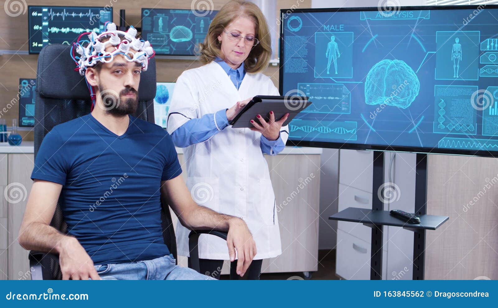 Female Neurologist Reading Data from Brainwave Scanning Headset Stock ...