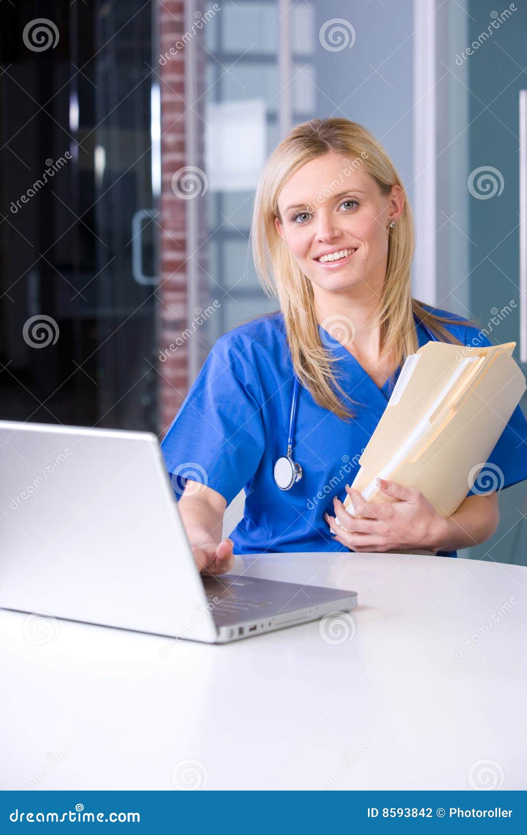 Female nurse at a desk stock photo. Image of document - 8593842