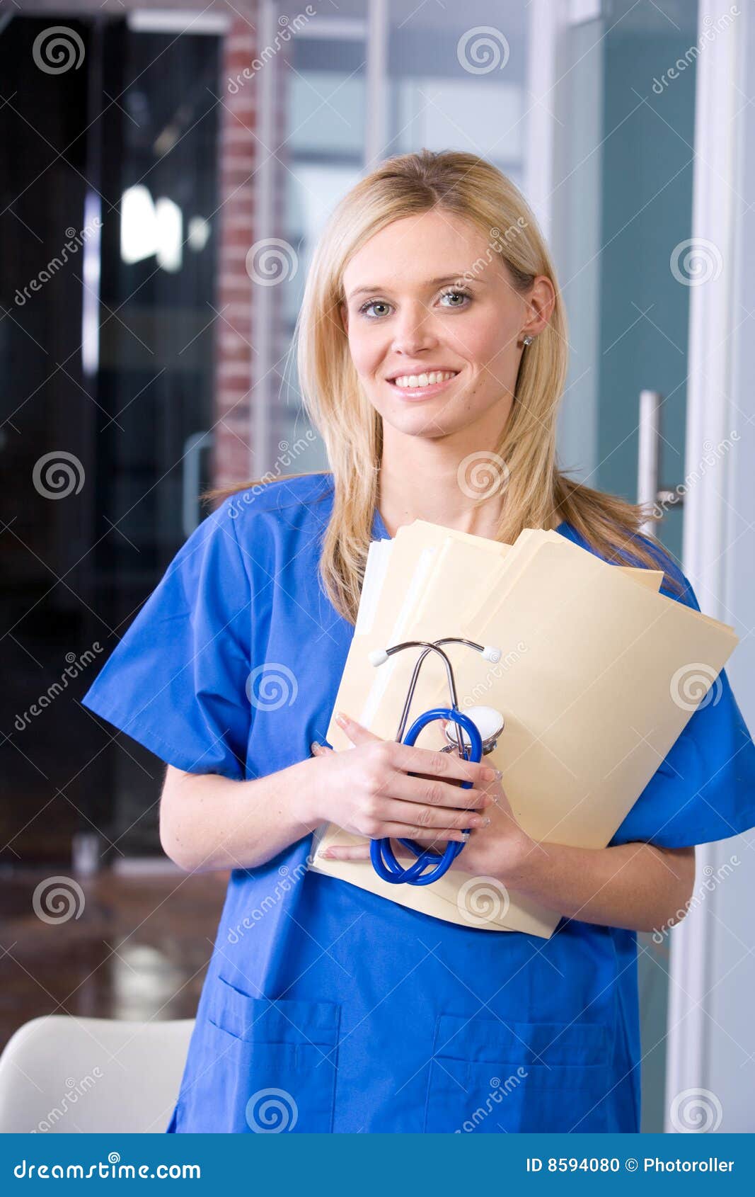 Female Nurse at a Desk Working Stock Photo - Image of document, blue ...
