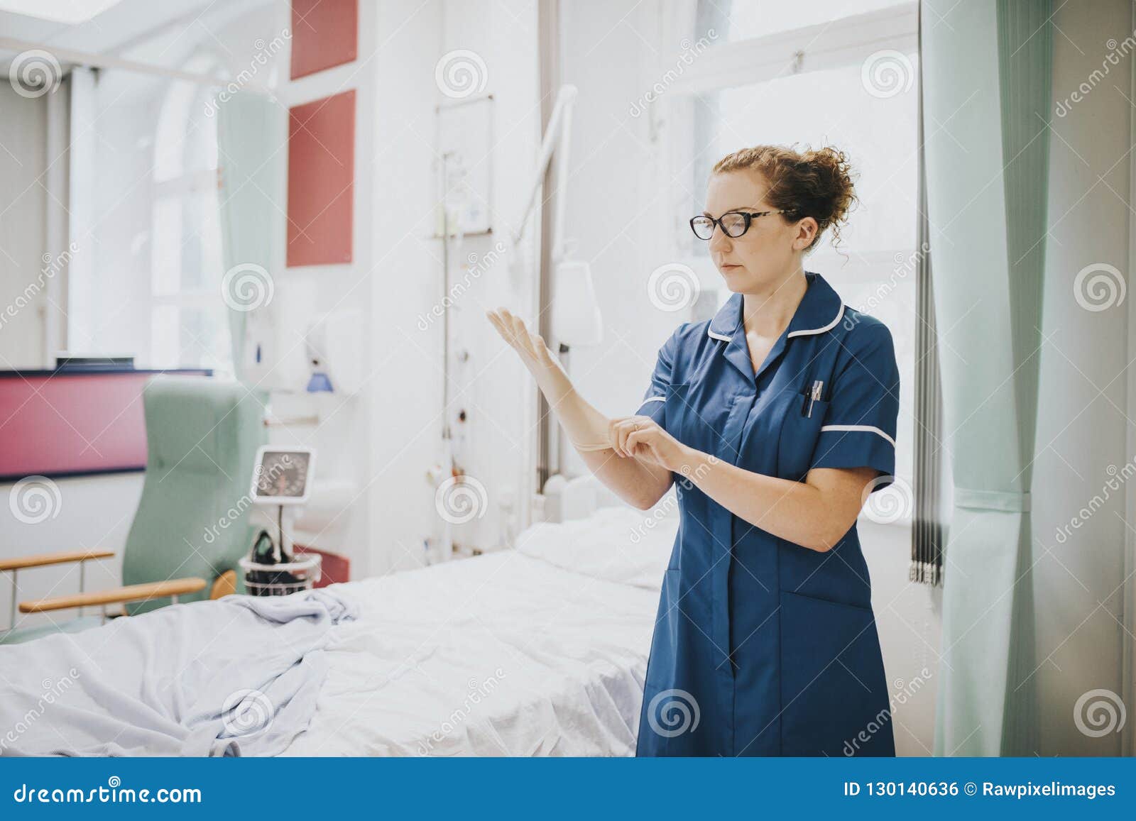 Female Nurse Putting on a Glove Stock Photo - Image of assistant ...