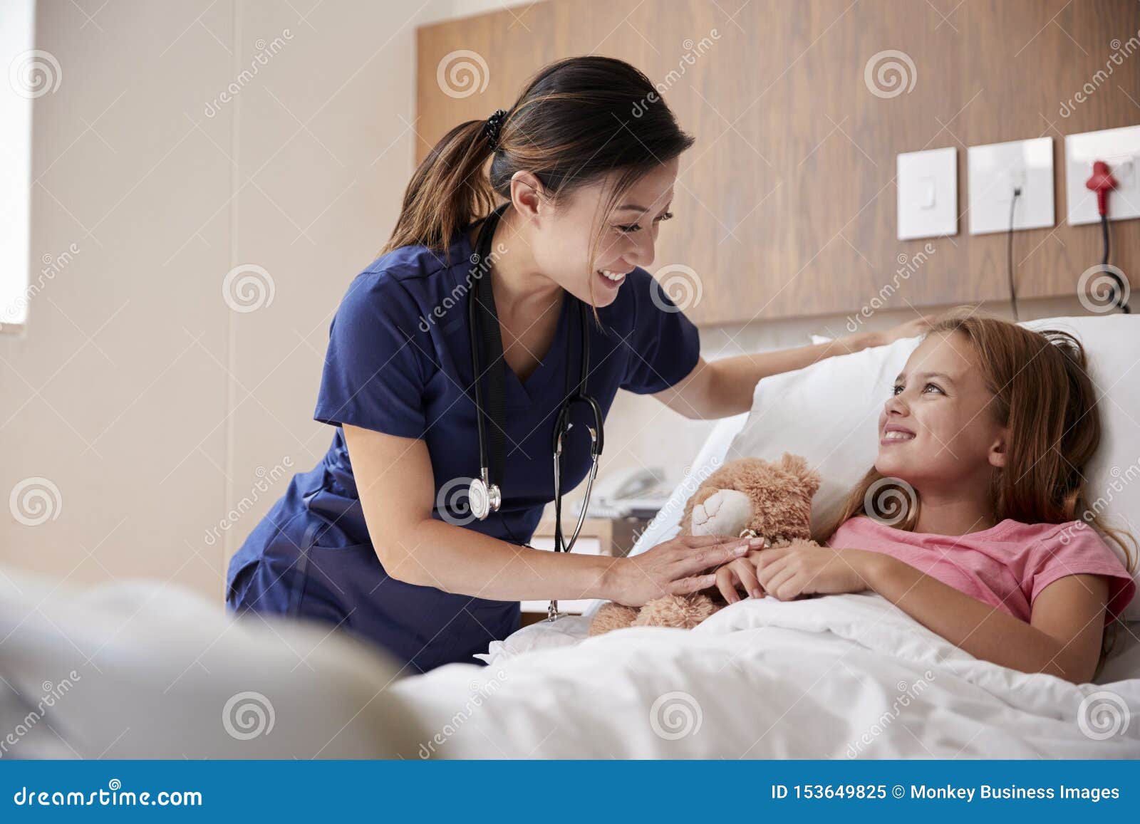 Female Nurse Visiting Girl Lying in Hospital Bed Hugging Teddy Bear ... Female Nurse Visiting Girl Lying in Hospital Bed Hugging Teddy Bear ...
